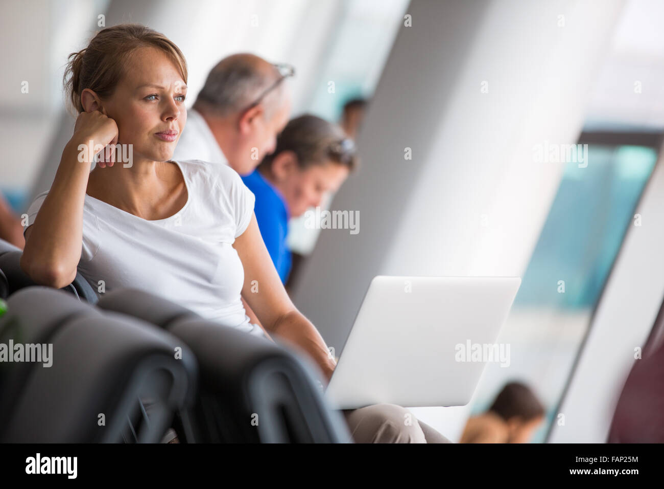 Young female passenger at the airport, about to check-in Stock Photo ...