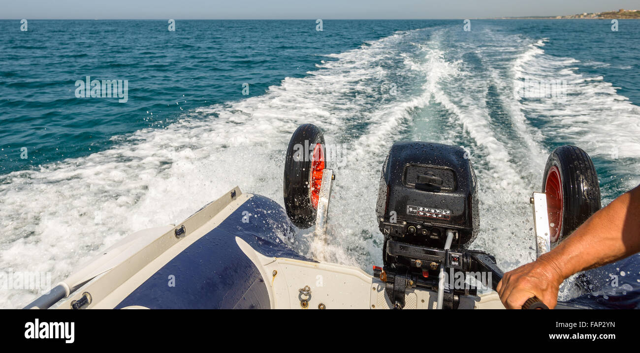 boat running fast leaving a white trail on the blue sea Stock Photo - Alamy