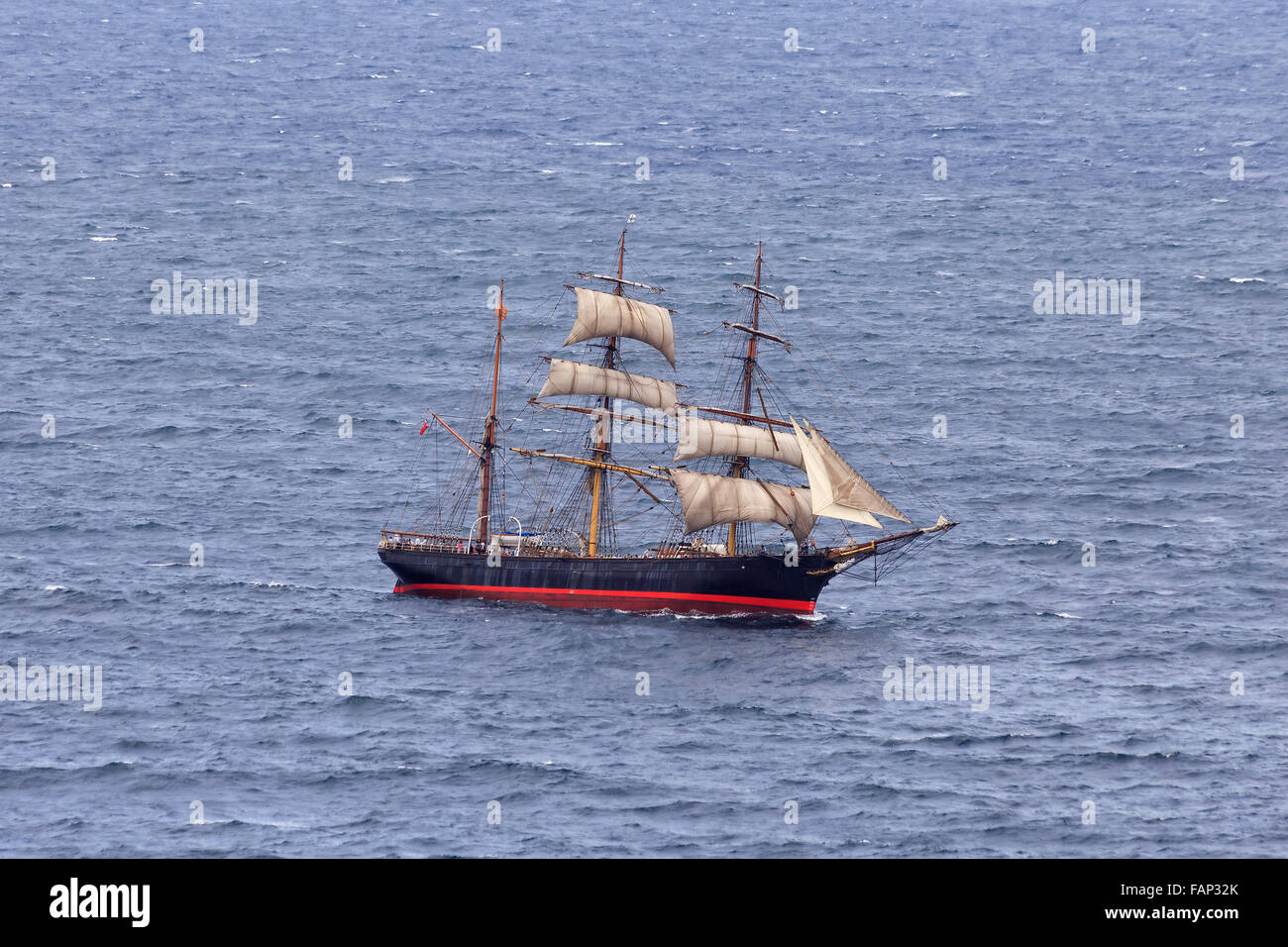 tall ship with sails at open sea on a sunny day aerial side-view during ...
