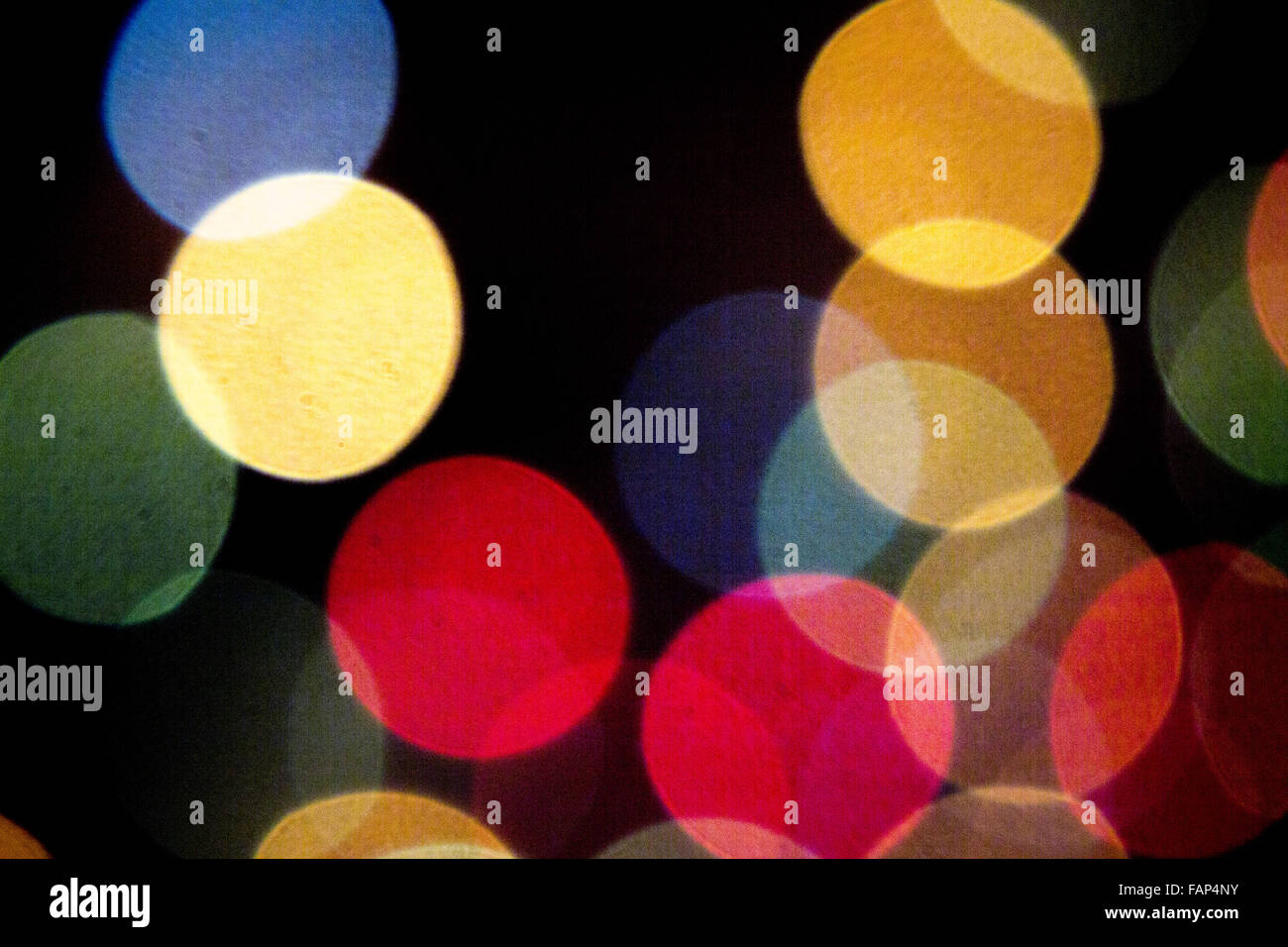 Colored defocused party lights at night abstract photo on black ...