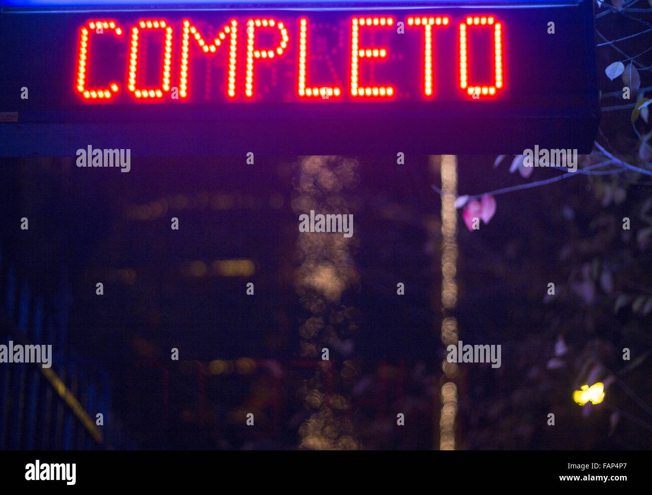 Car park light sign at night photo in Spain showing completo in Spanish ...