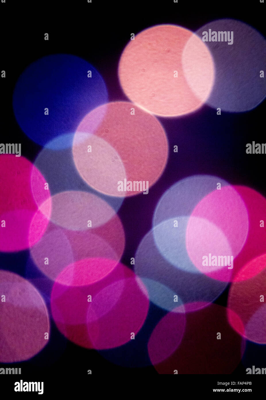 Colored defocused party lights at night abstract photo on black ...