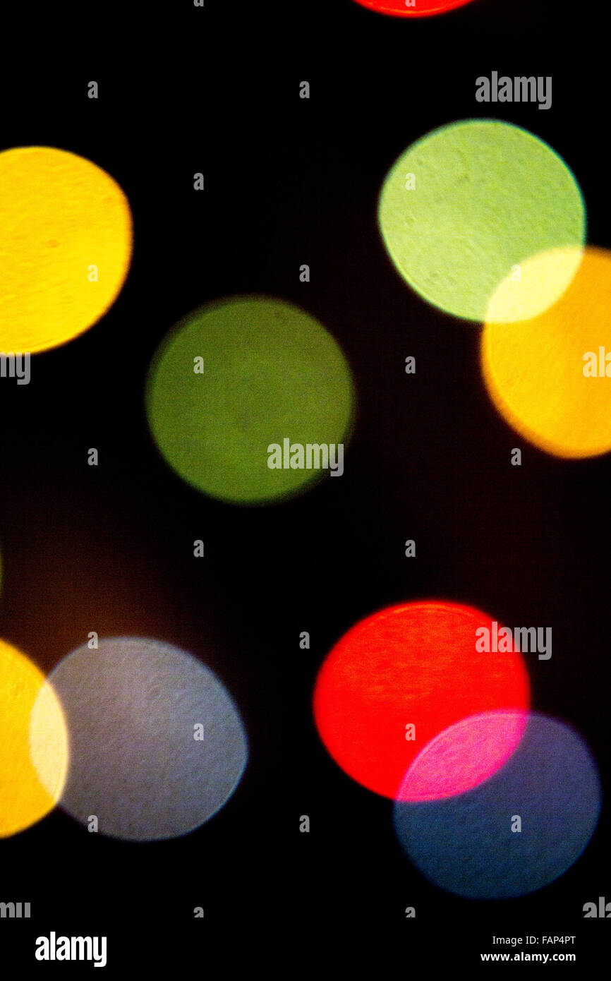 Colored defocused party lights at night abstract photo on black ...