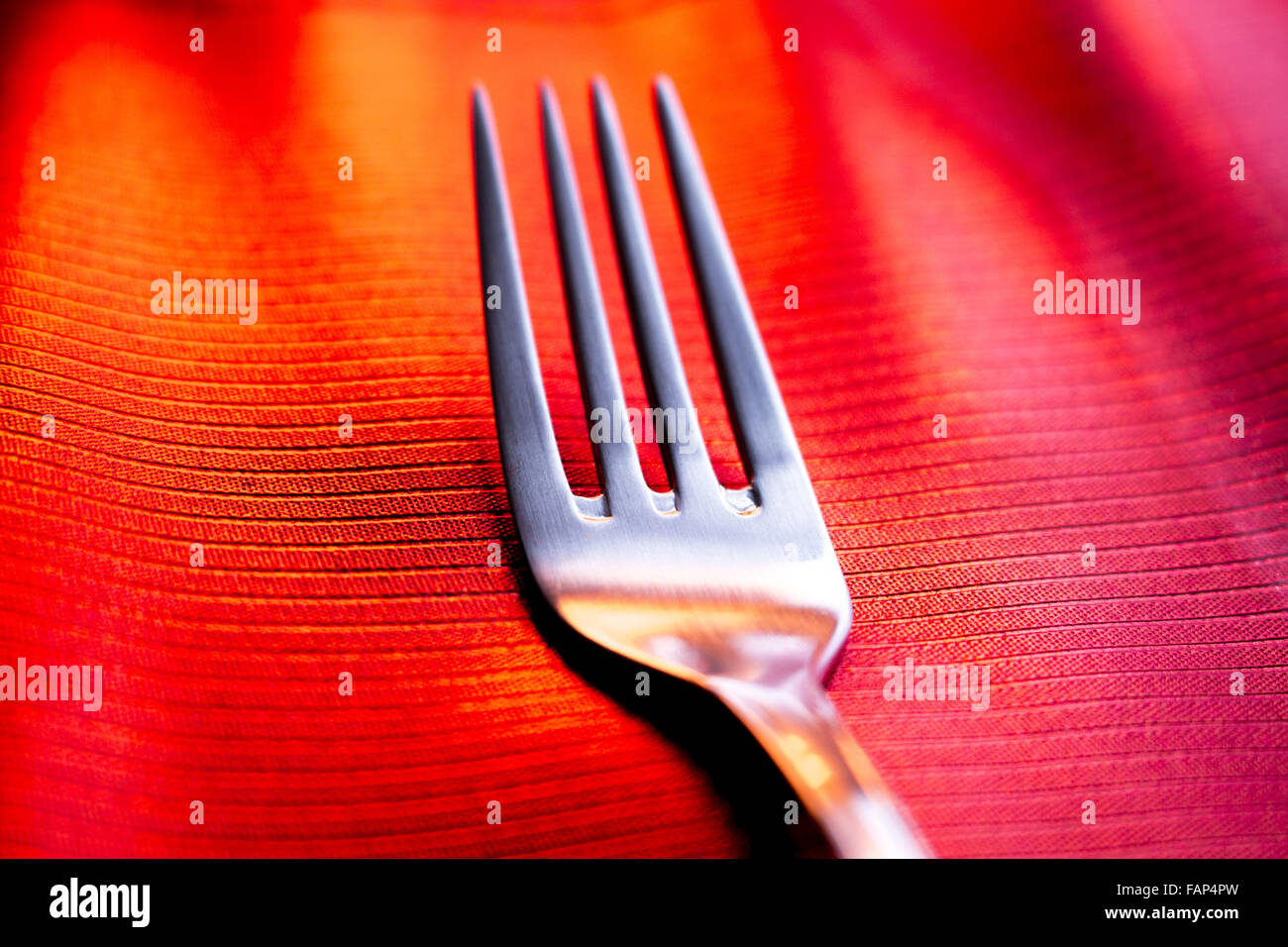 Stainless steel fork on dinner table place setting in restaurant ...