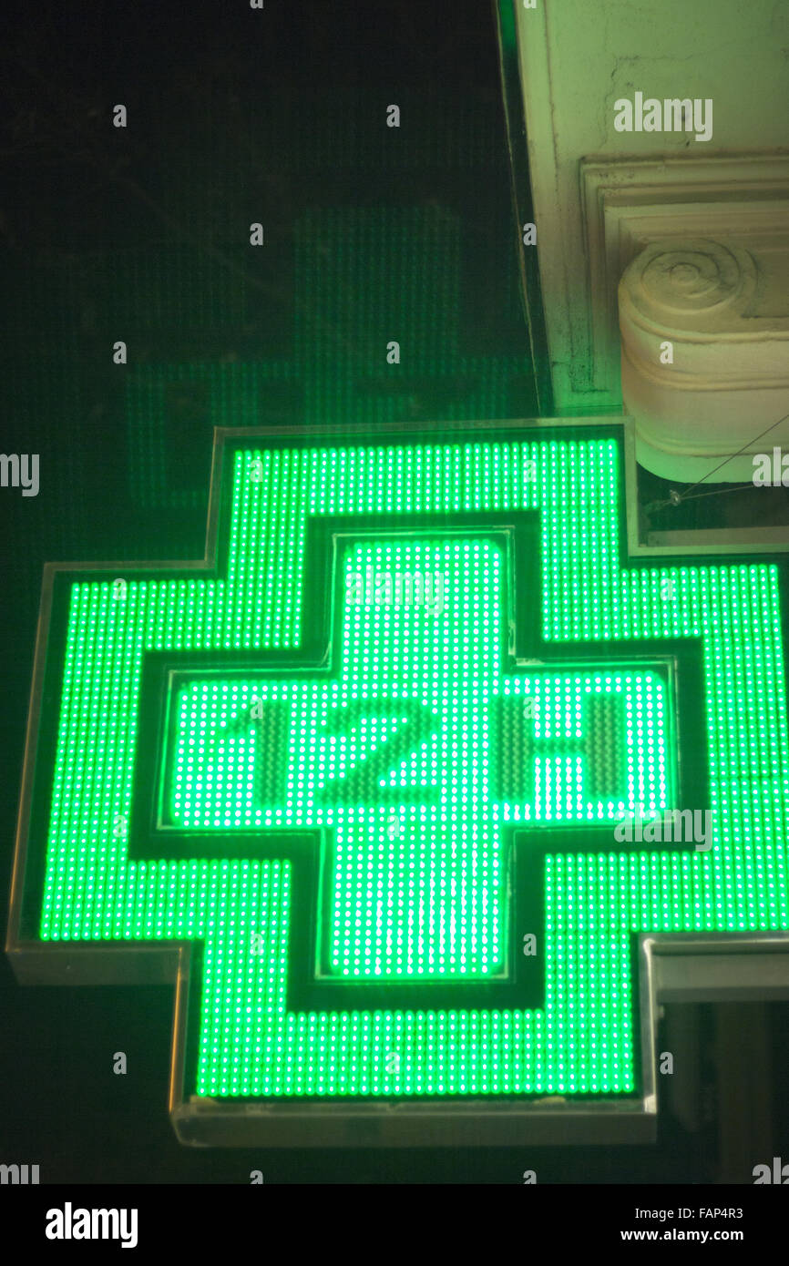 Pharmacy neon light chemists 12 hour open cross sign at night photo ...