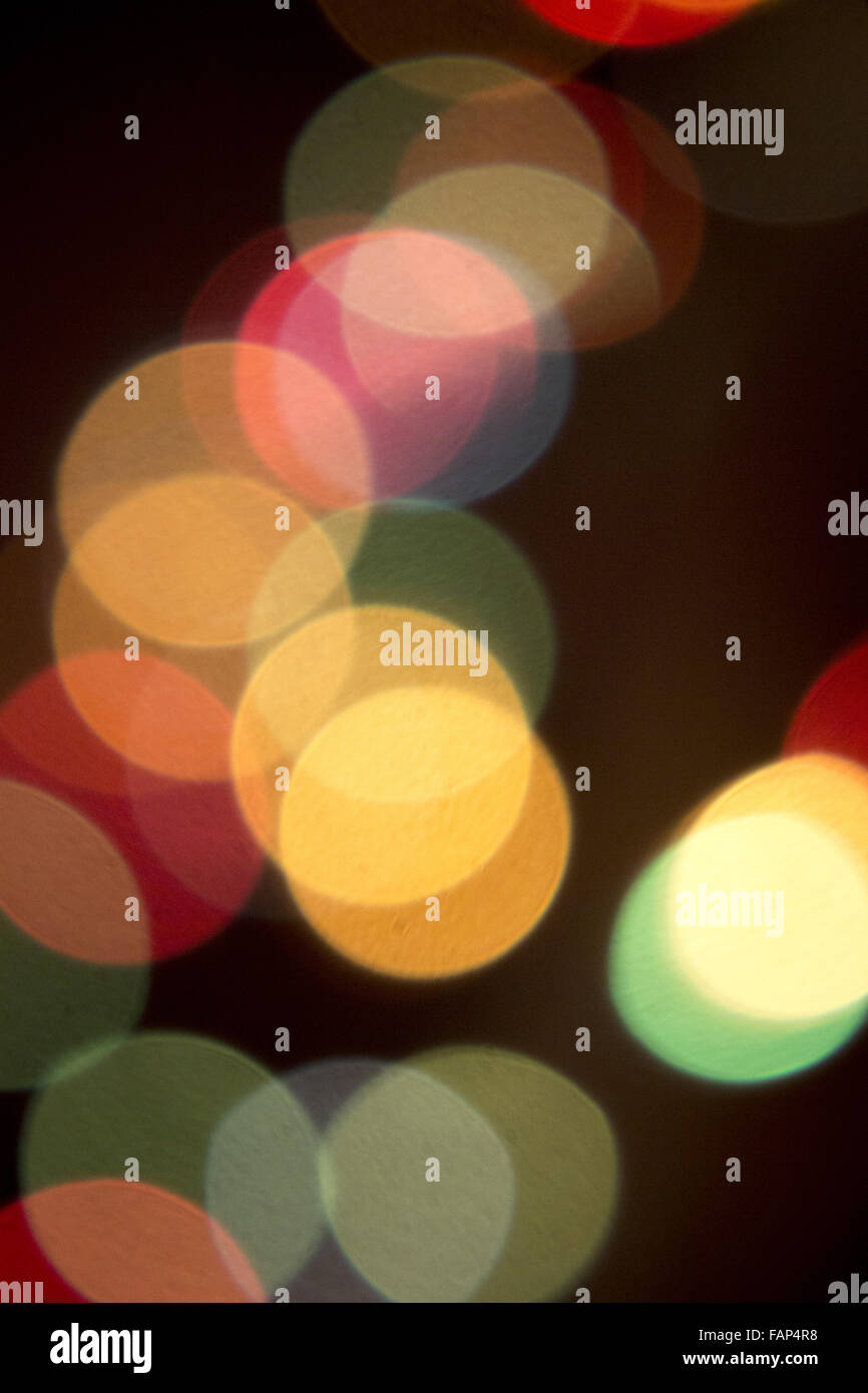 Colored defocused party lights at night abstract photo on black ...