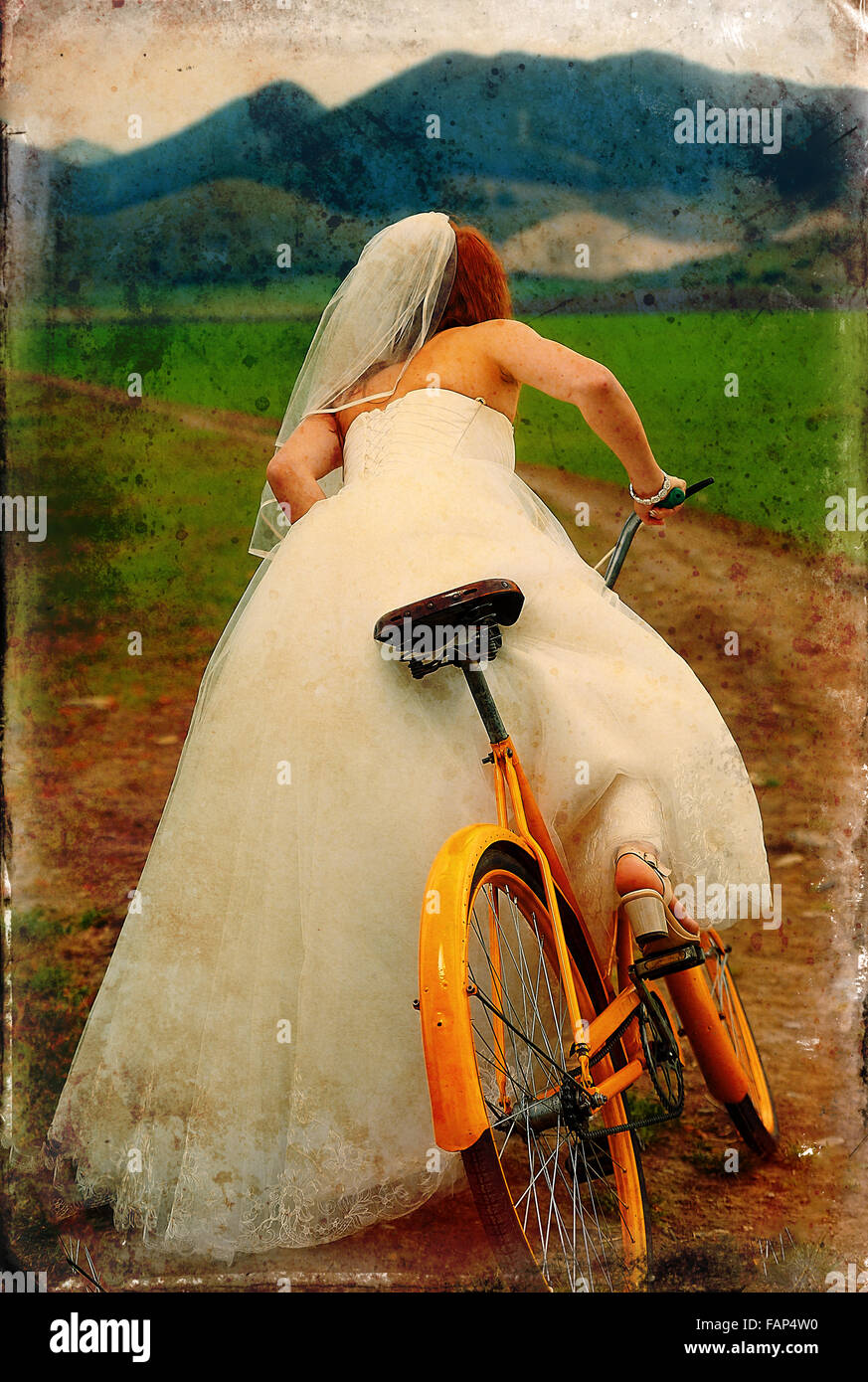 bride on orange bike in beautiful wedding dress with lace in landscape ...