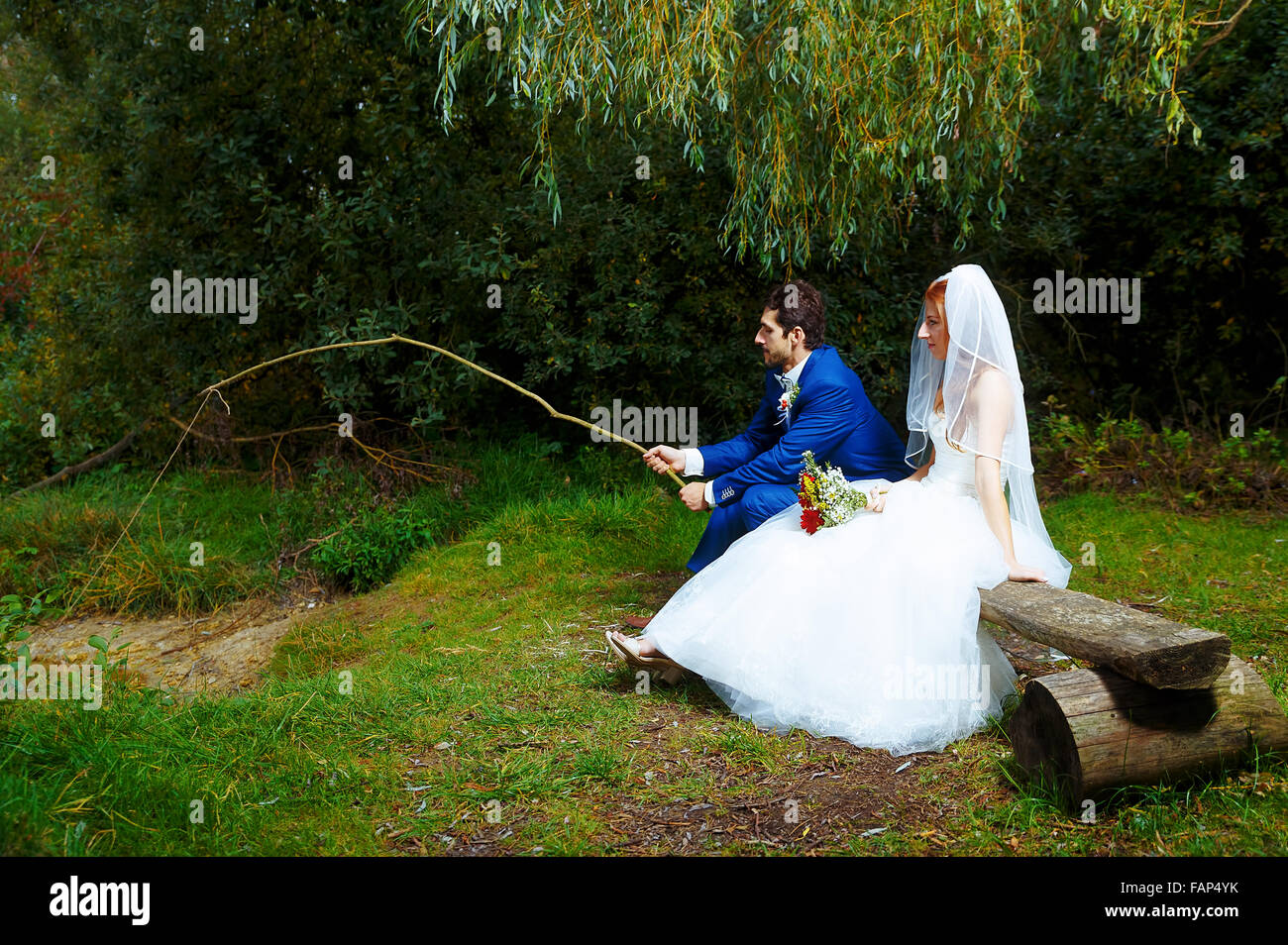 bride and groom fishing together - romantic wedding concept Stock Photo ...