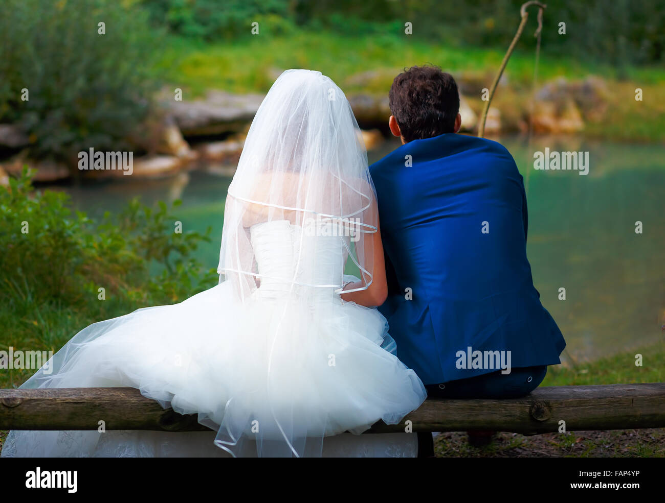 bride and groom fishing together - romantic wedding concept Stock Photo ...