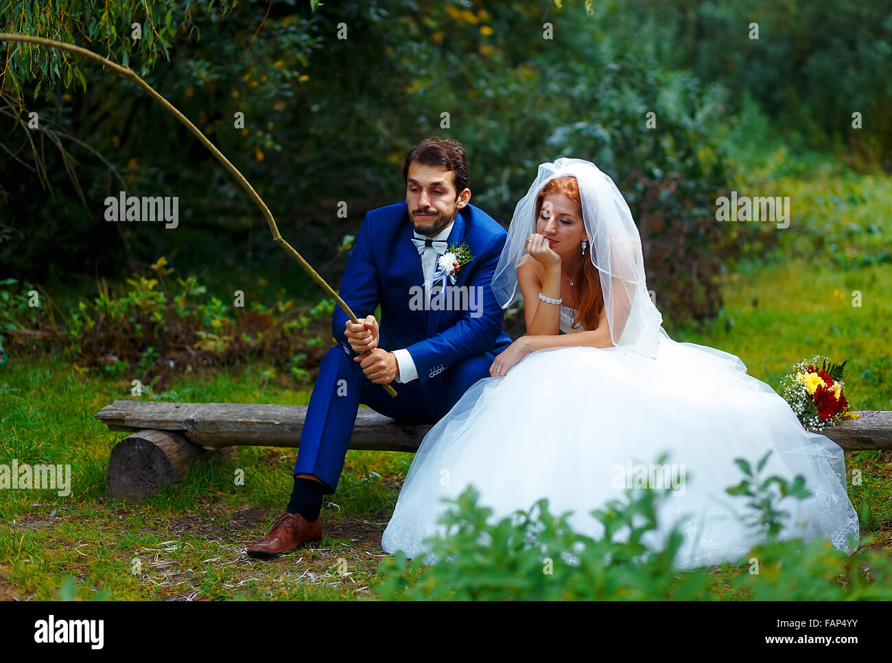 bride and groom fishing together - romantic wedding concept Stock Photo ...