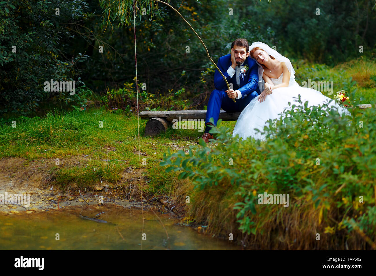 bride and groom fishing together - romantic wedding concept Stock Photo ...