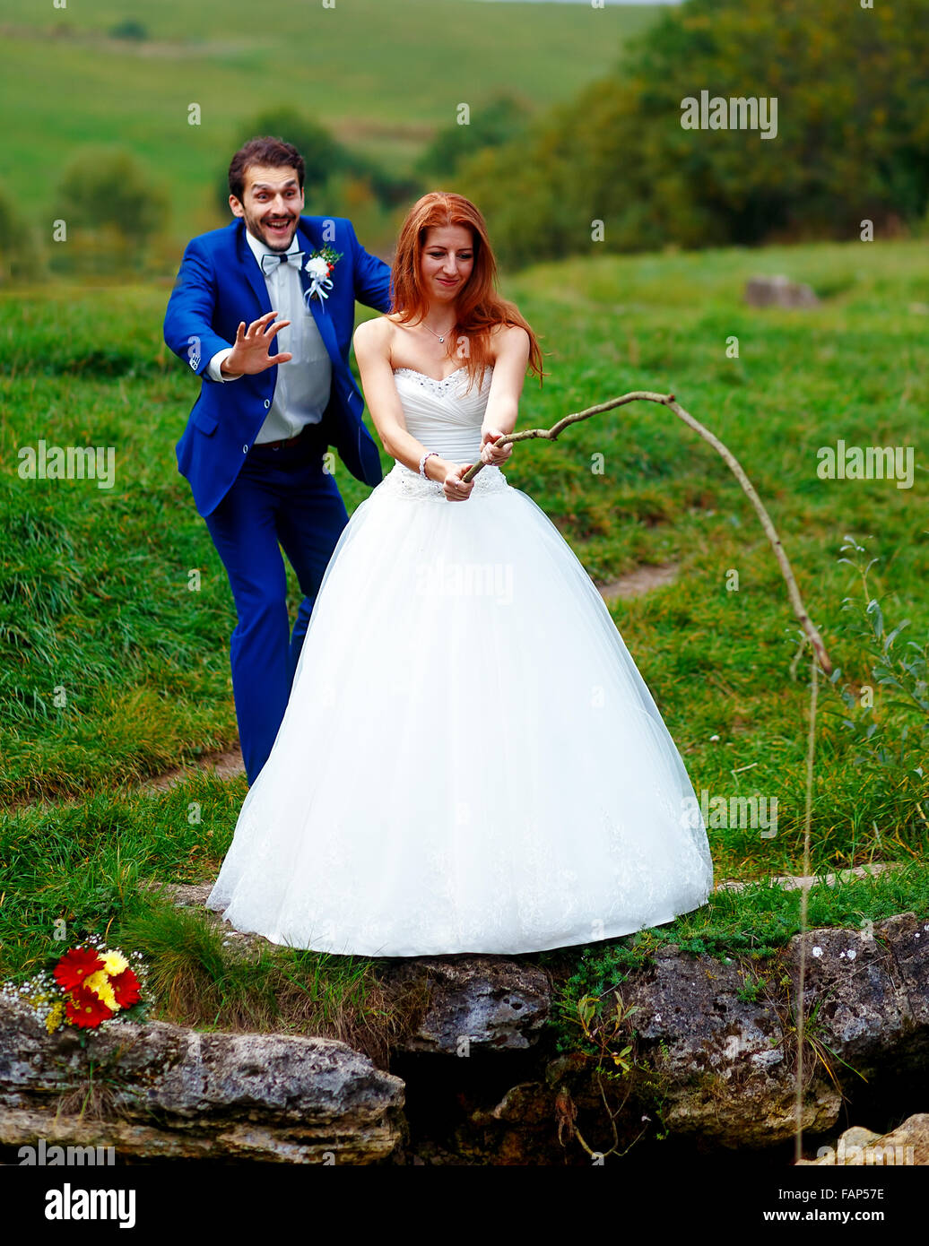 bride and groom fishing together - romantic wedding concept Stock Photo ...