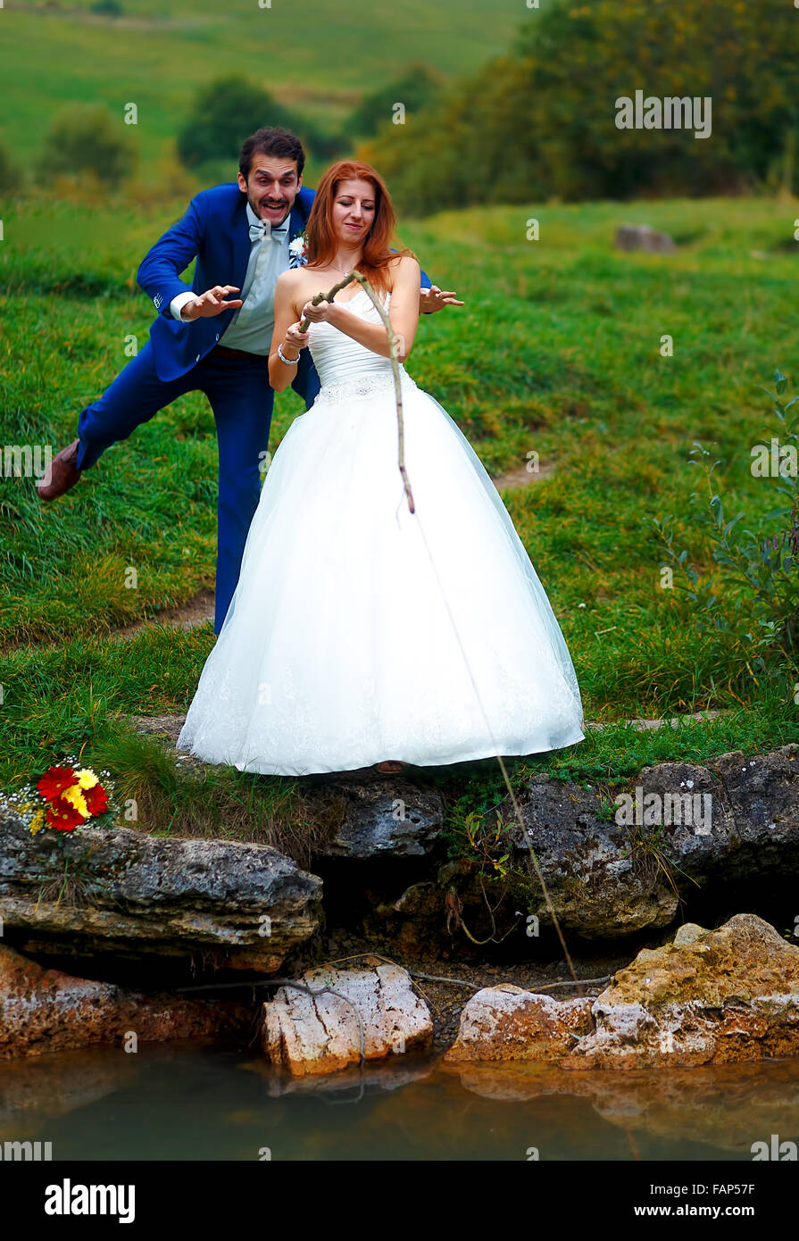 bride and groom fishing together - romantic wedding concept Stock Photo ...