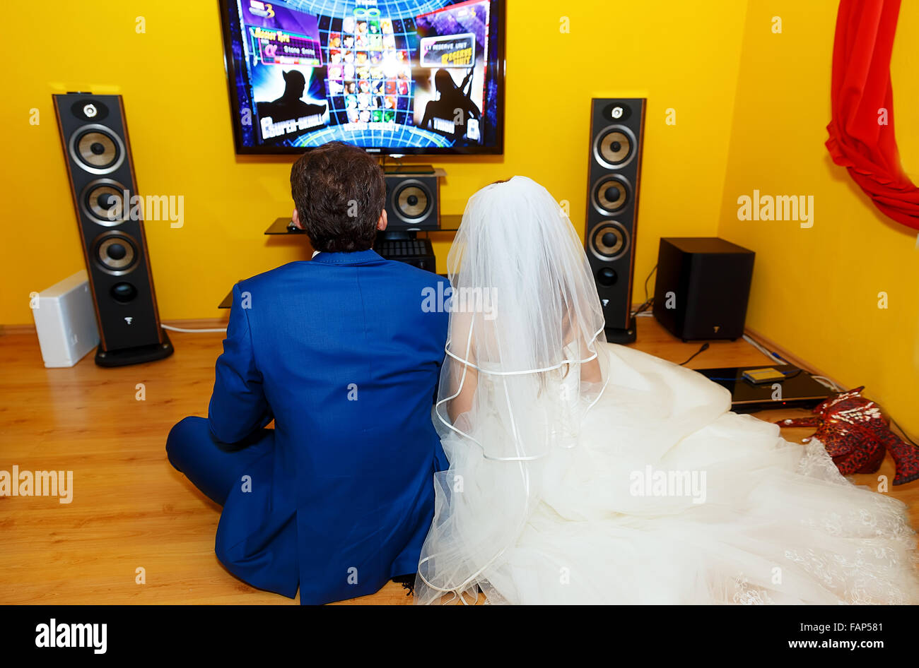 bride and groom playing together videogames with joysticks - gaming and ...