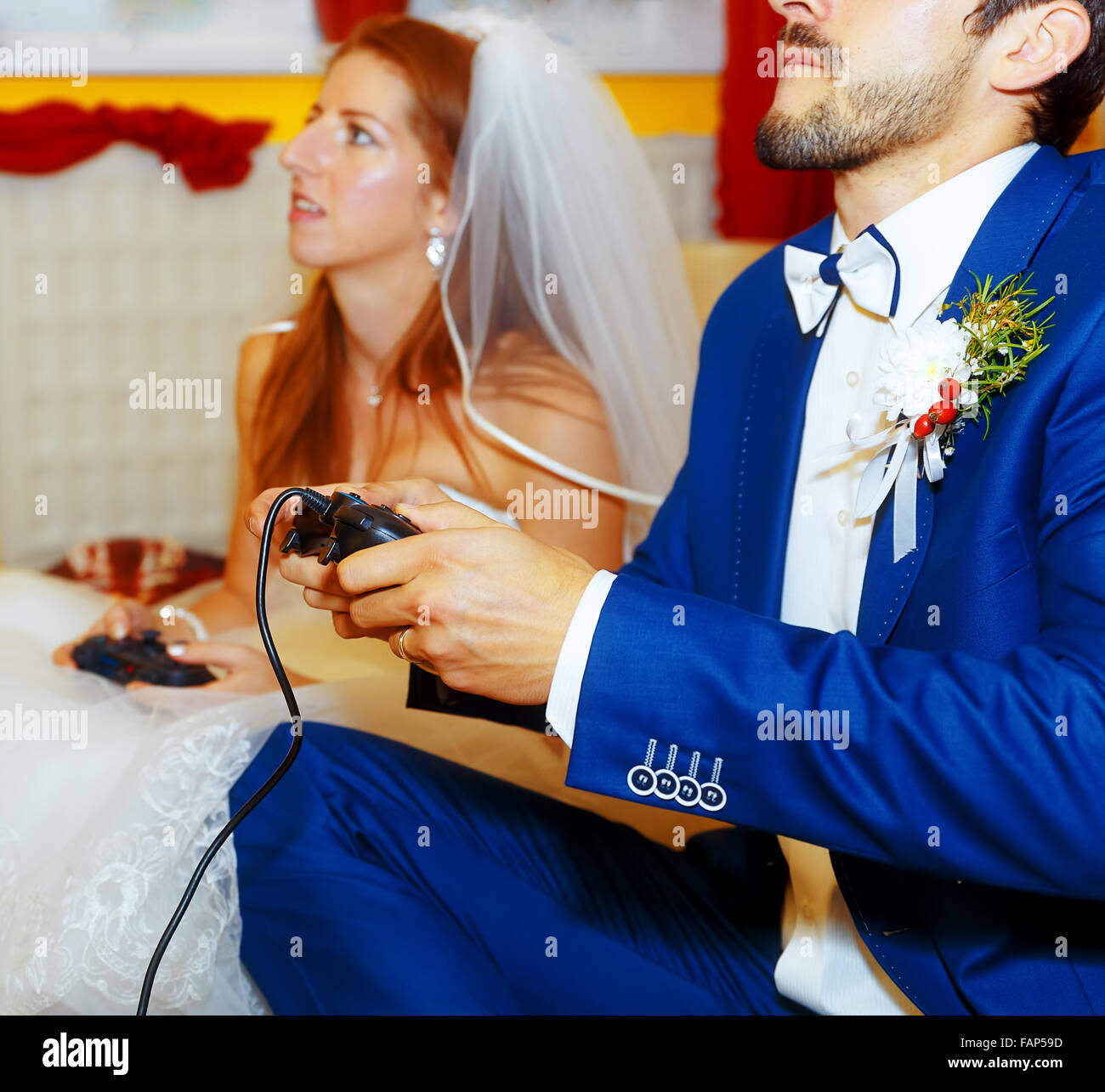 bride and groom playing together videogames with joysticks - gaming and ...