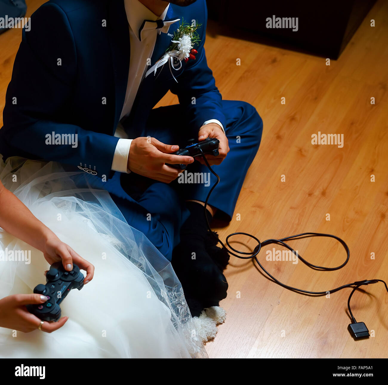 bride and groom playing together videogames with joysticks - gaming and ...