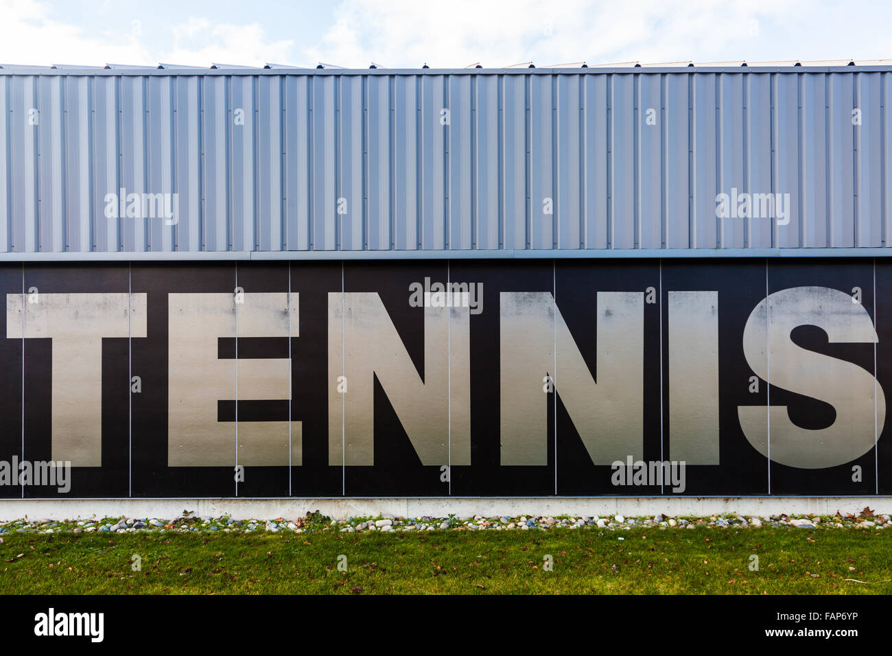 Large graphic sign on the exterior wall of an indoor tennis court Stock ...