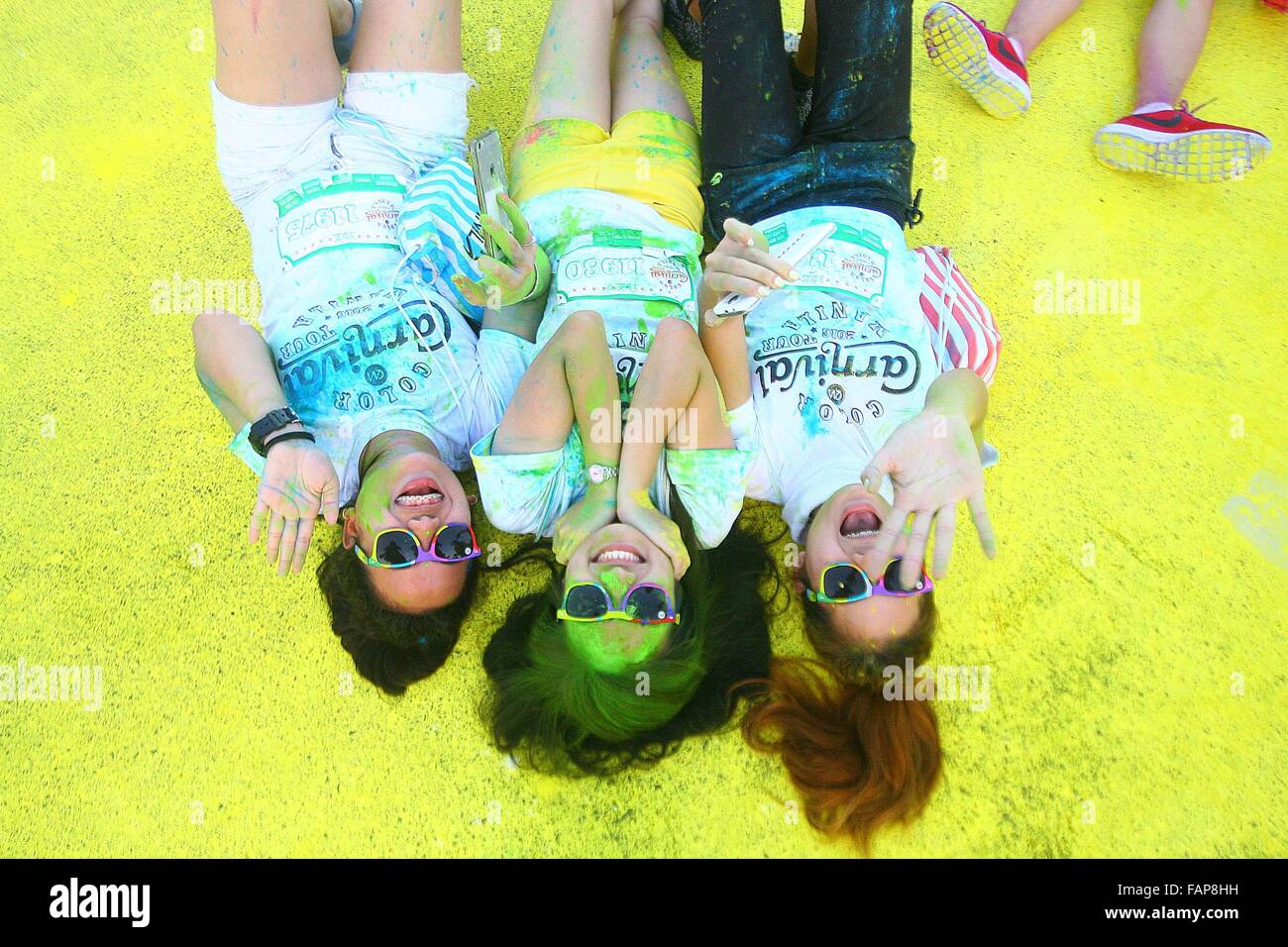 Pasay City, Philippines. 3rd Jan, 2016. Runners lie on a road covered ...