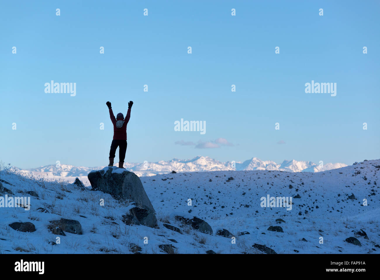 Hiker on Oregon's Wallowa Lake moraine in winter. The Seven Devils ...