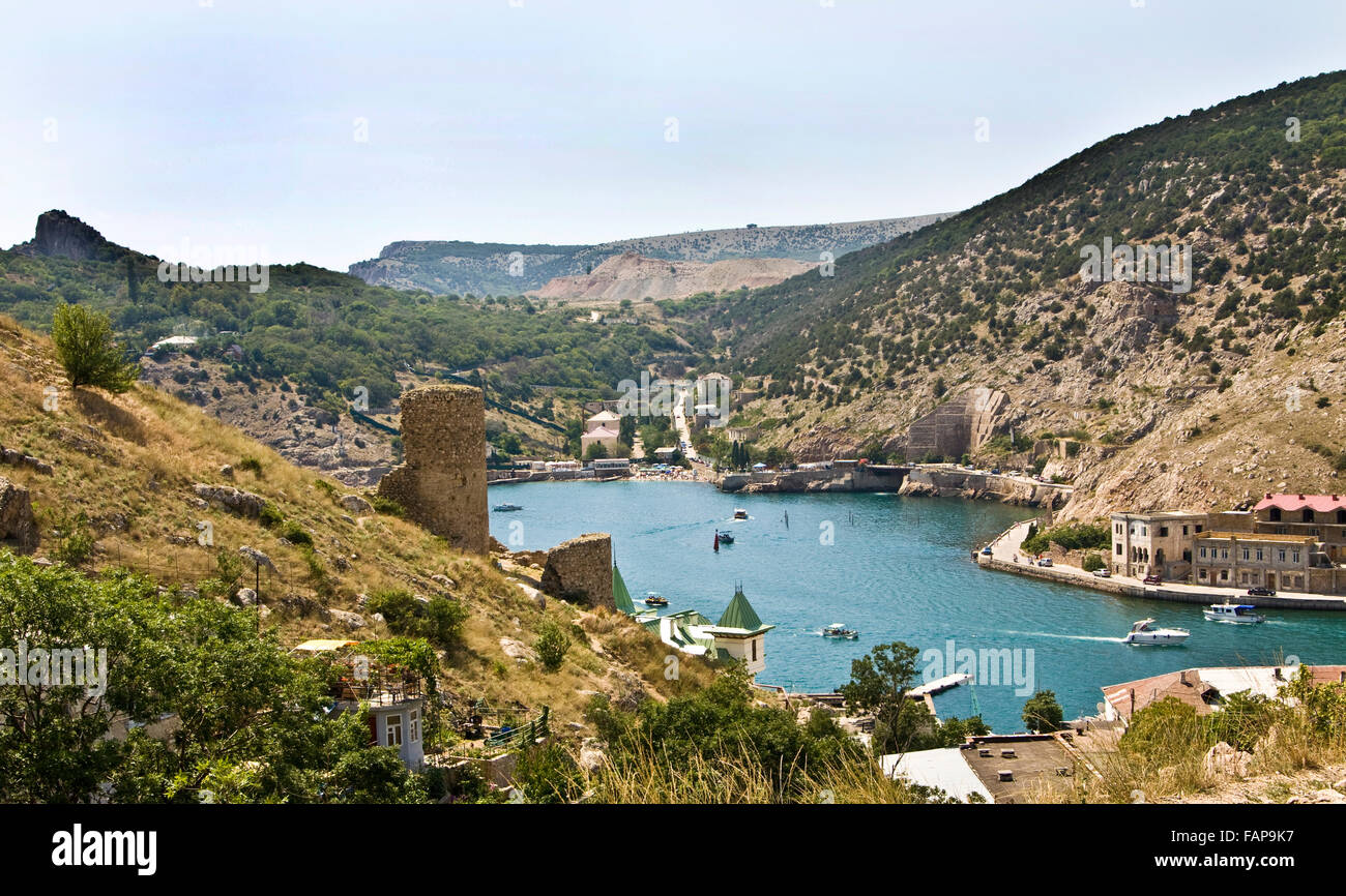 Sea landscape - harbour with rocks around and ruins of ancient castle ...