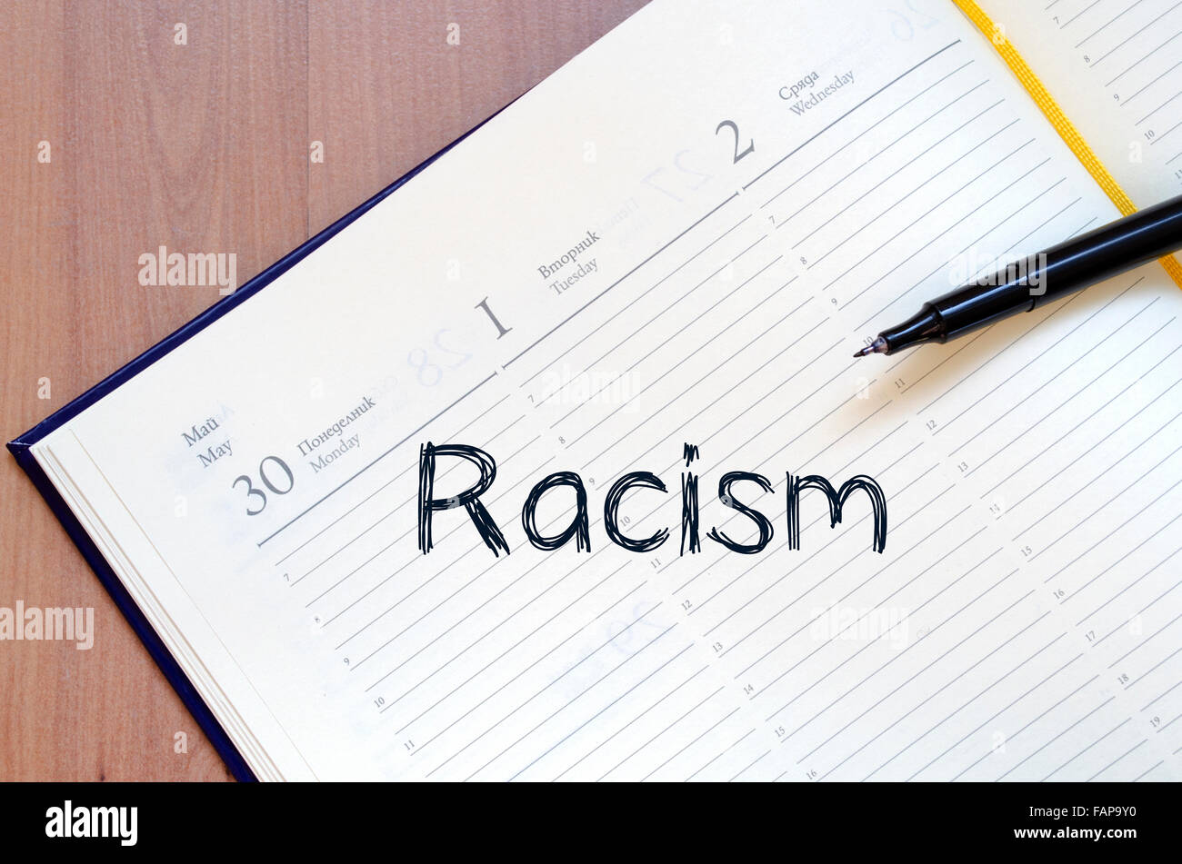 Racism text concept write on notebook with pen Stock Photo - Alamy