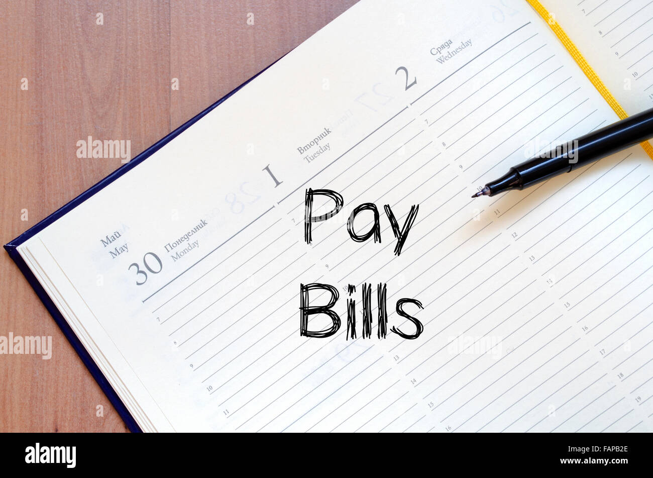 Pay bills text concept write on notebook with pen Stock Photo - Alamy