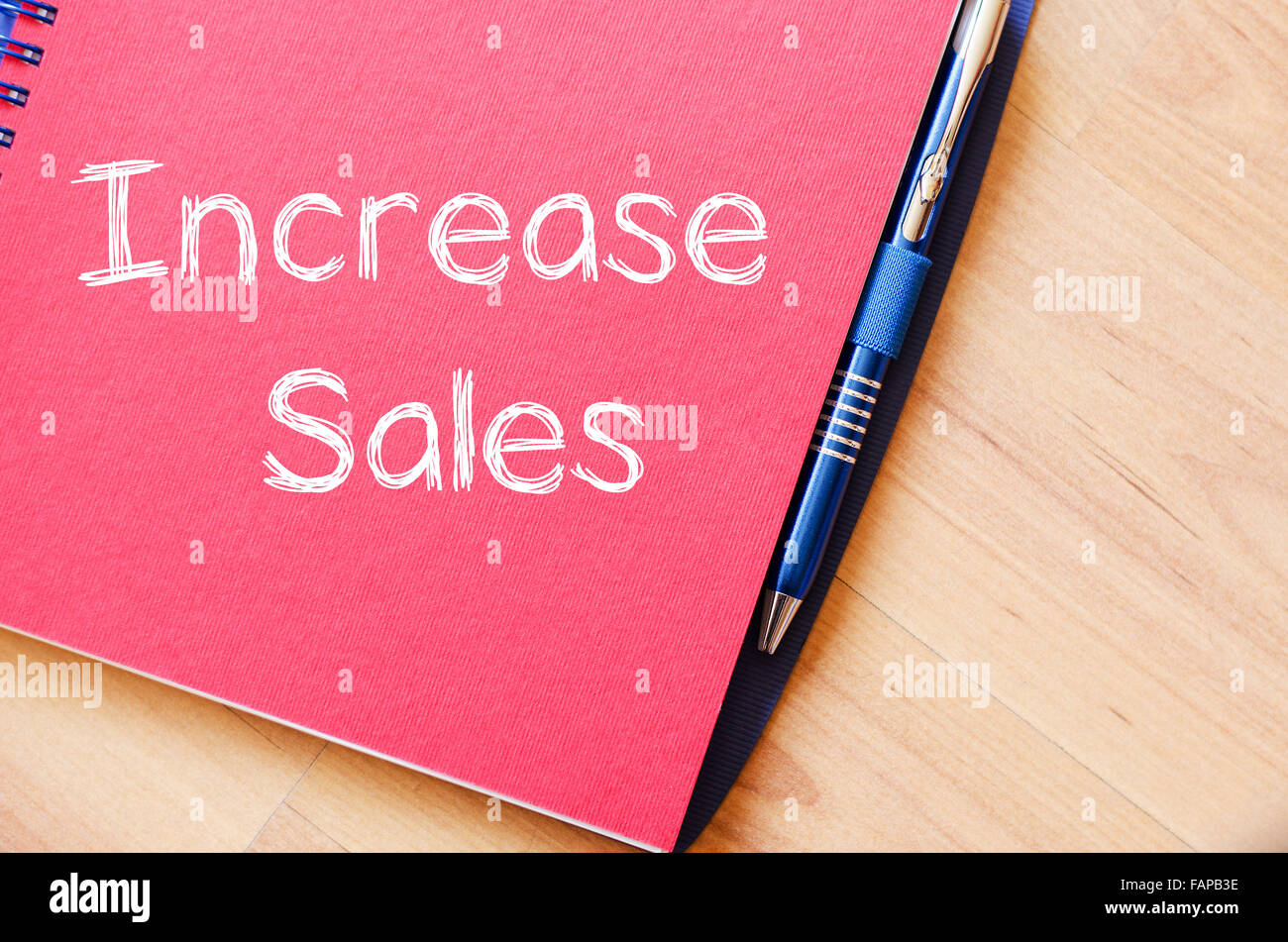 Increase sales text concept write on notebook with pen Stock Photo - Alamy