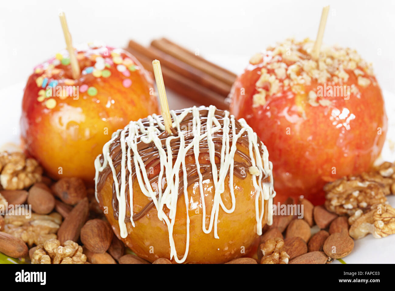 Apple in candy decorated with chocolate, nuts and confectionery ...