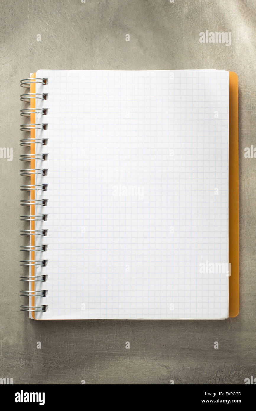 checked notebook at old background Stock Photo - Alamy