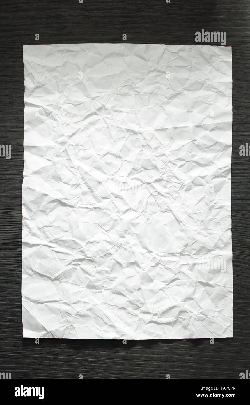 wrinkled paper at wooden background Stock Photo - Alamy