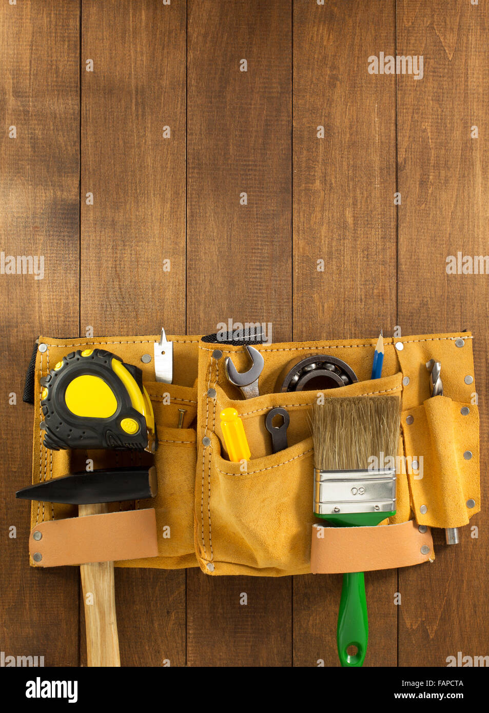 tools and instruments in belt on wooden background Stock Photo - Alamy
