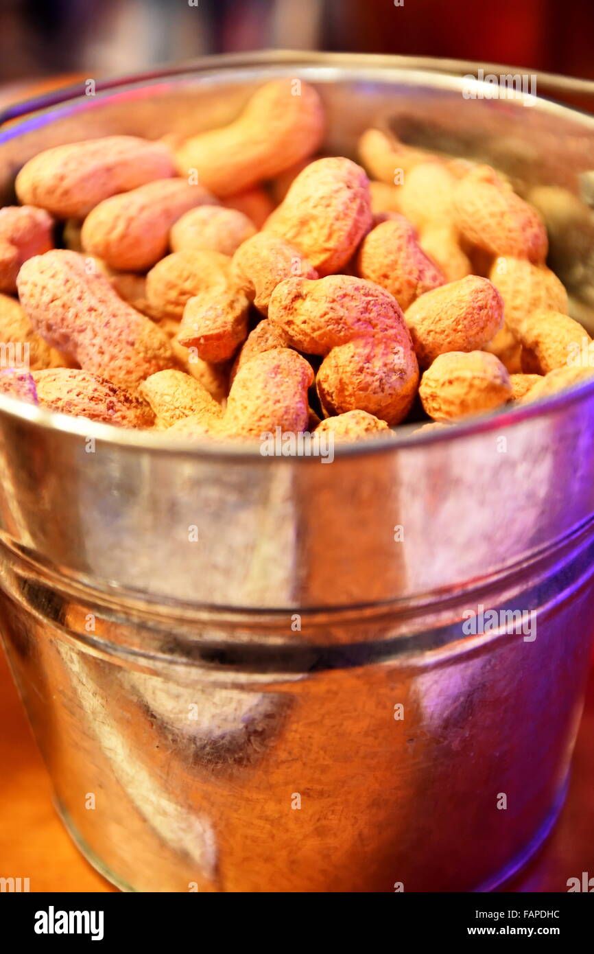 Peanuts bucket at the restaurant Stock Photo - Alamy