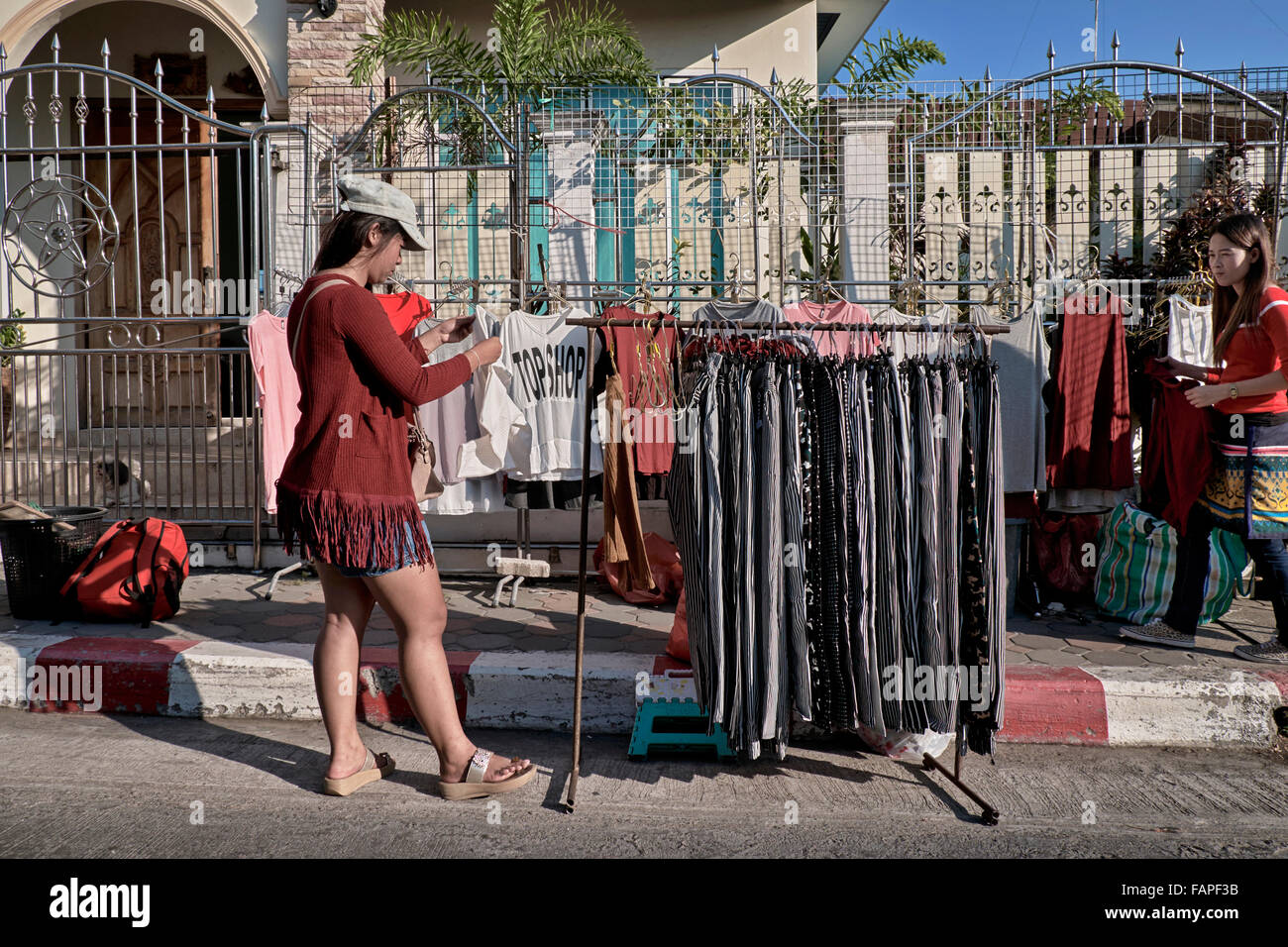 Thailand street market with clothing sales on the sidewalk. Thailand S ...