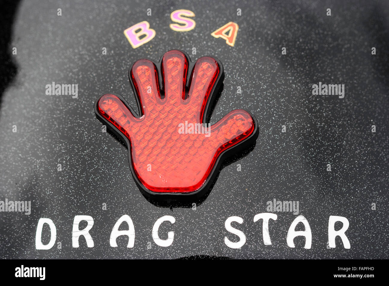 Close up of reflective Red hand BSA Drag Star logo badge with words ...