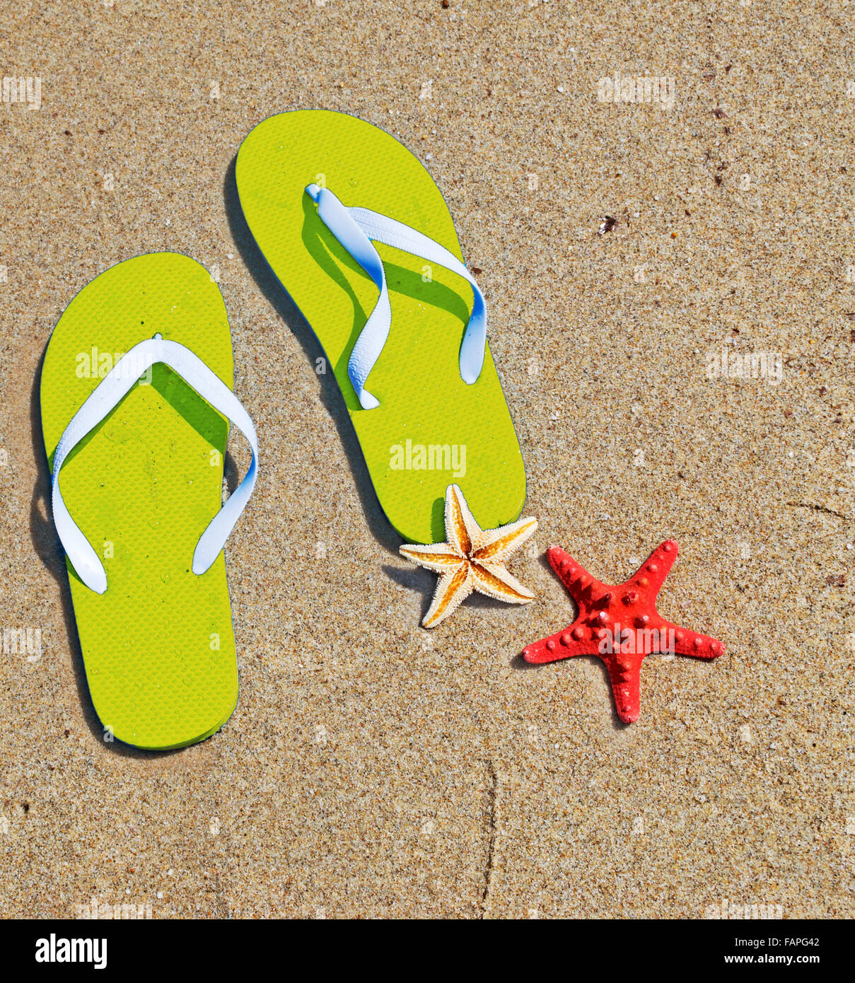 flip flops on the sand in a tropical beach Stock Photo - Alamy