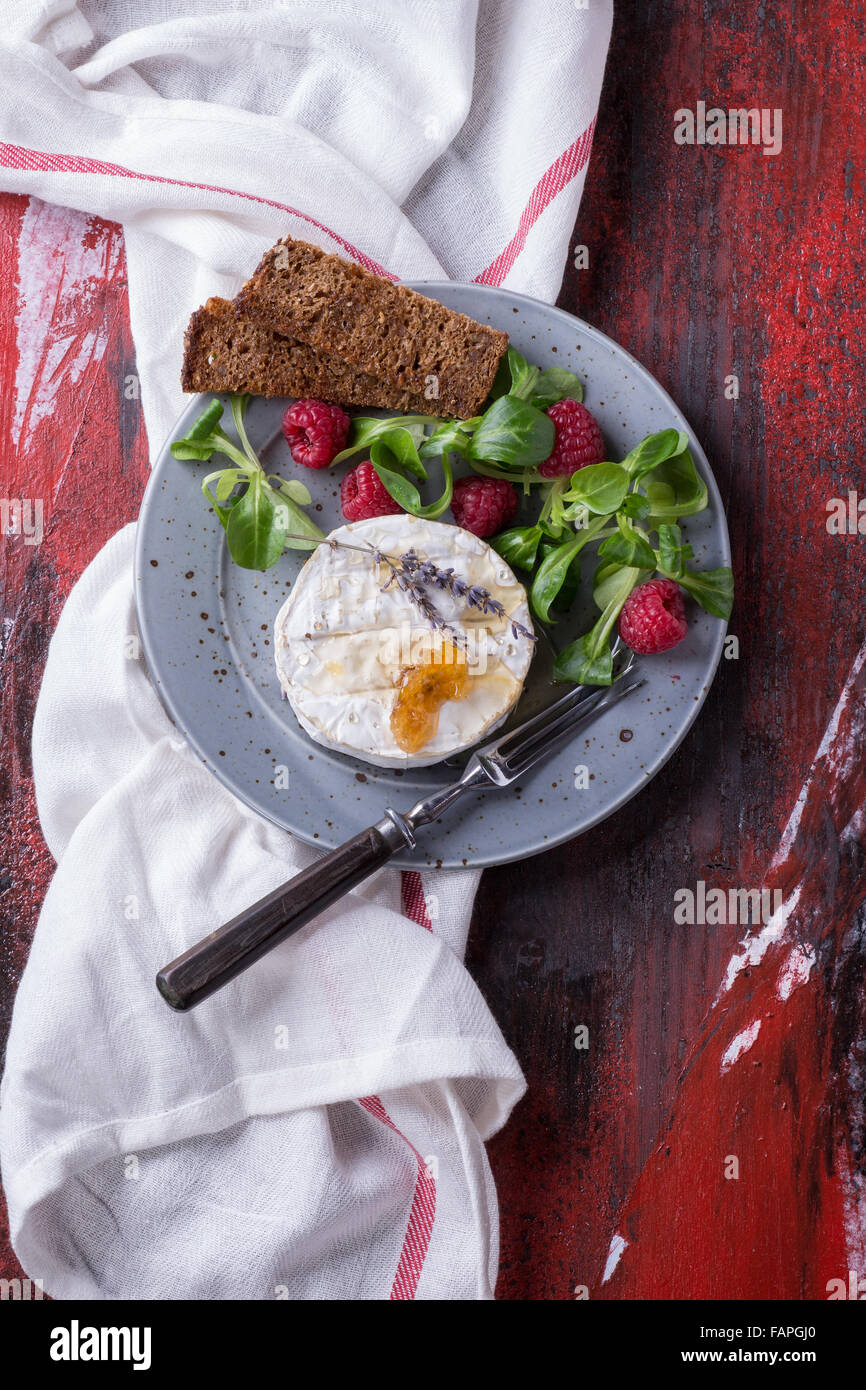 Goat cheese with honey and raspberries Stock Photo - Alamy