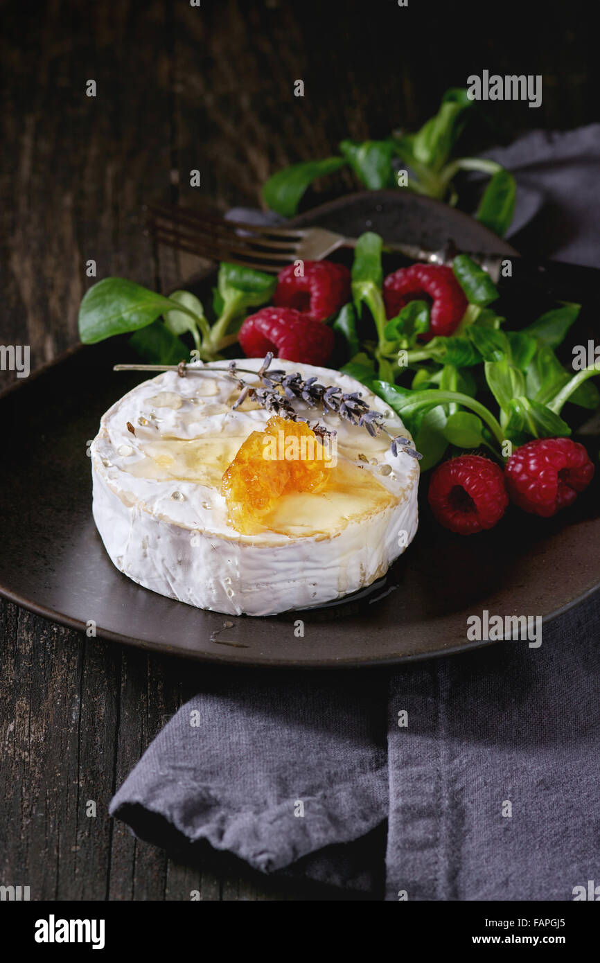 Goat cheese with honey and raspberries Stock Photo - Alamy