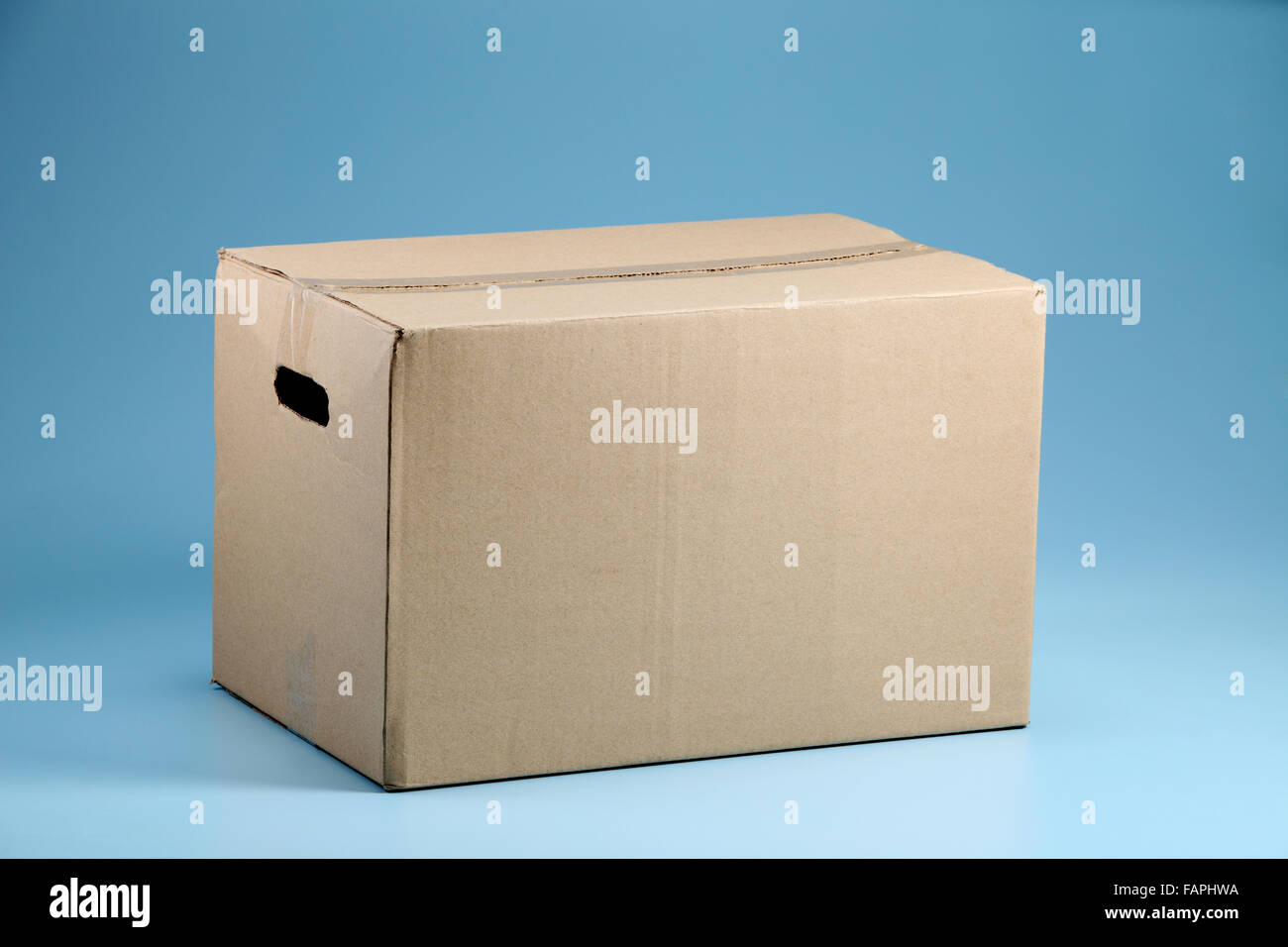 cardboard box on the blue background Stock Photo - Alamy