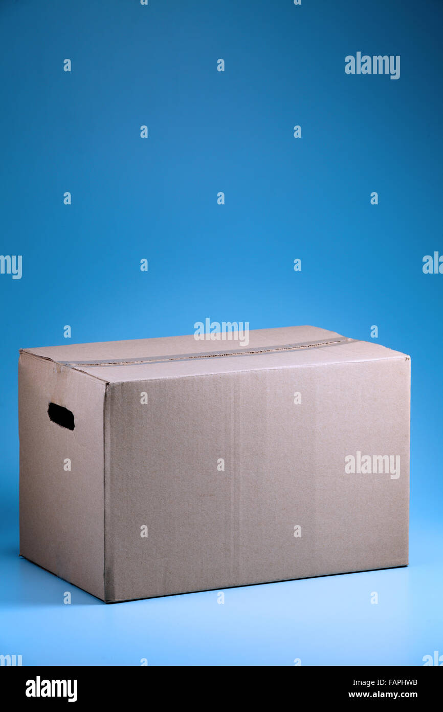 cardboard box on the blue background Stock Photo - Alamy