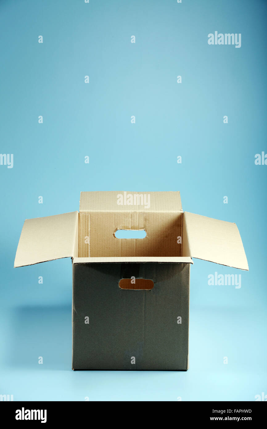 Empty Cardboard Box on the blue background Stock Photo - Alamy