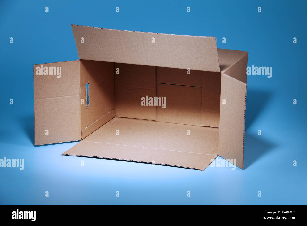 Empty Cardboard Box on the blue background Stock Photo - Alamy