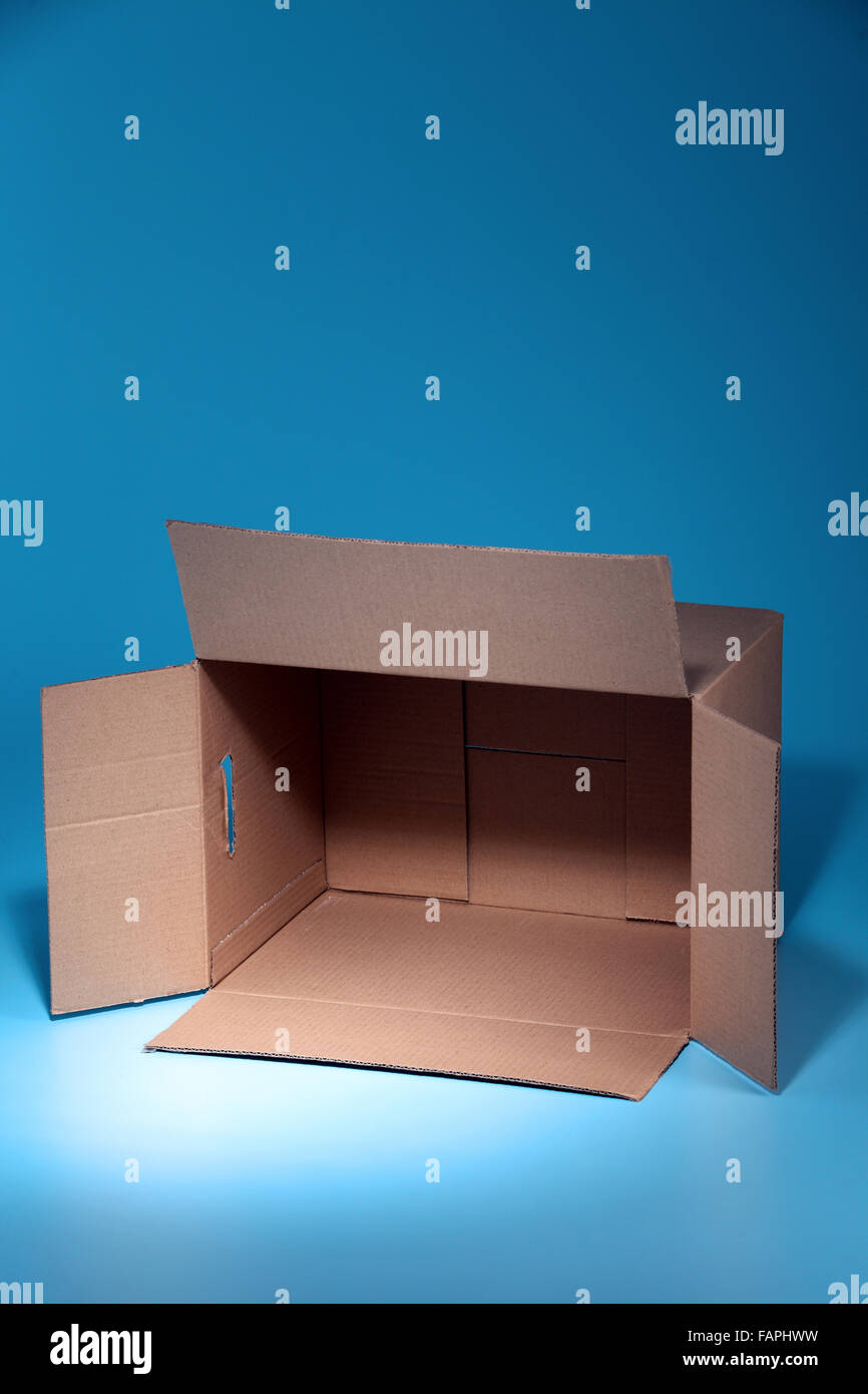 Empty Cardboard Box on the blue background Stock Photo - Alamy