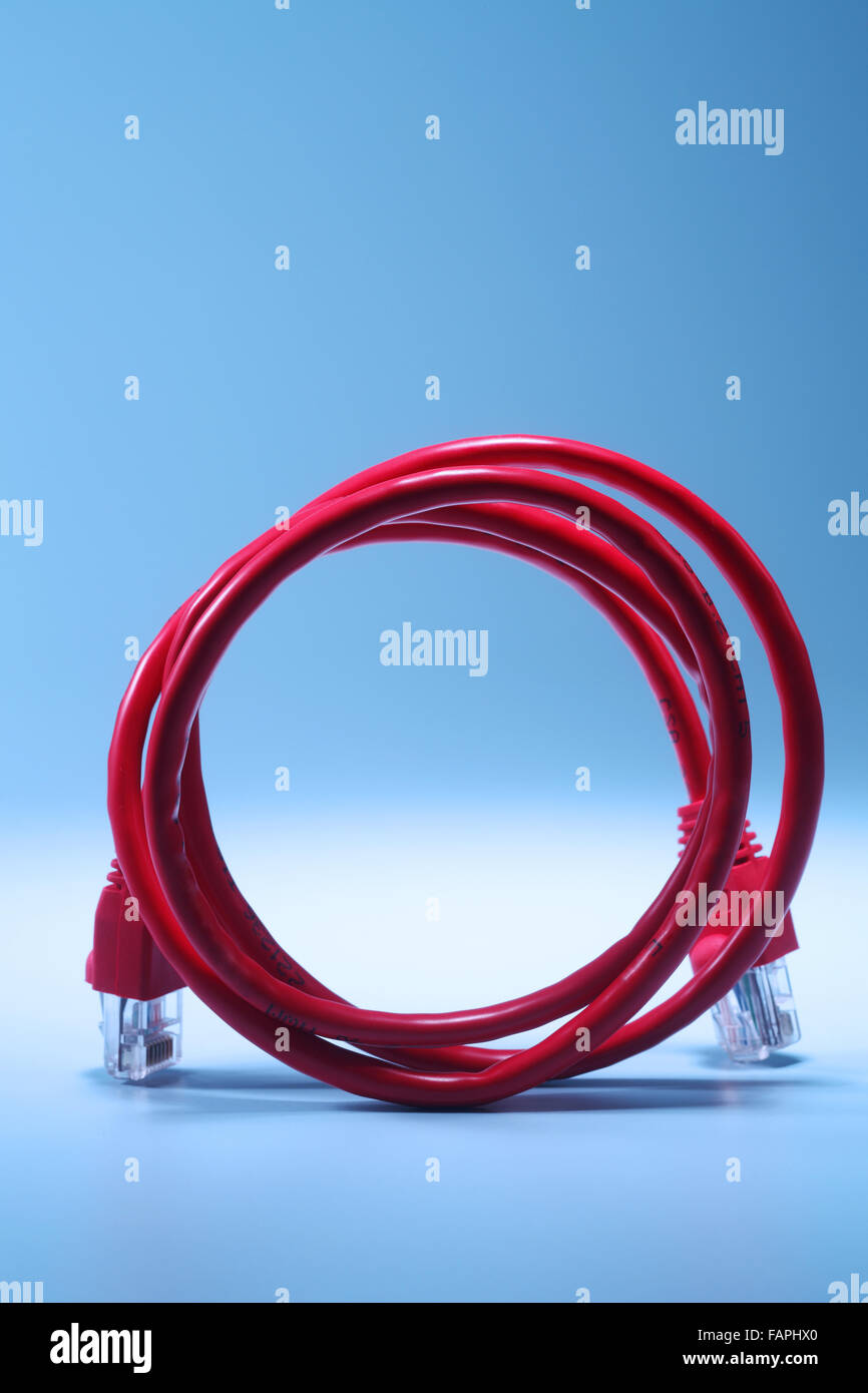 Ethernet cable against color background Stock Photo - Alamy