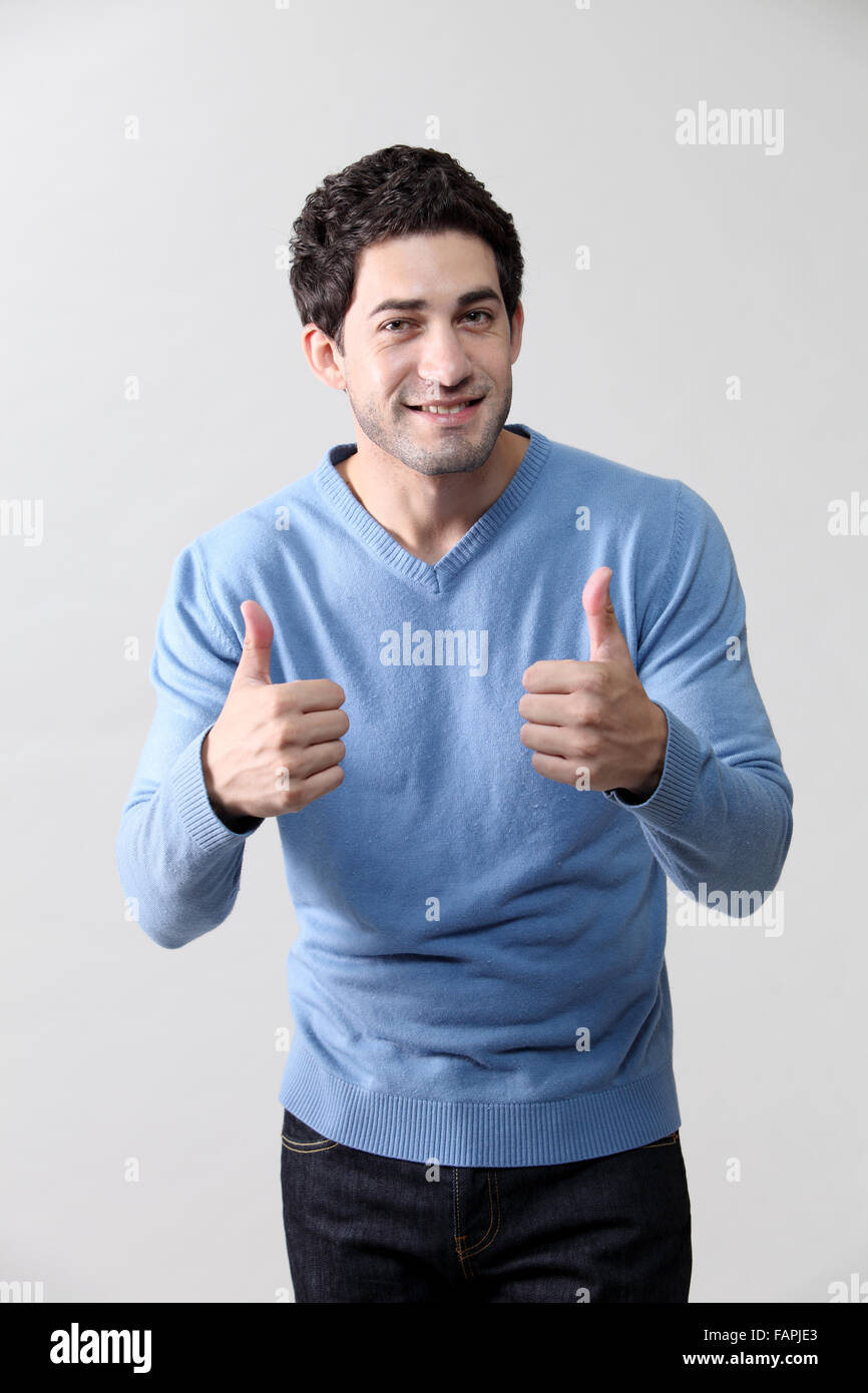 man in blue shirt with double thumb up Stock Photo - Alamy