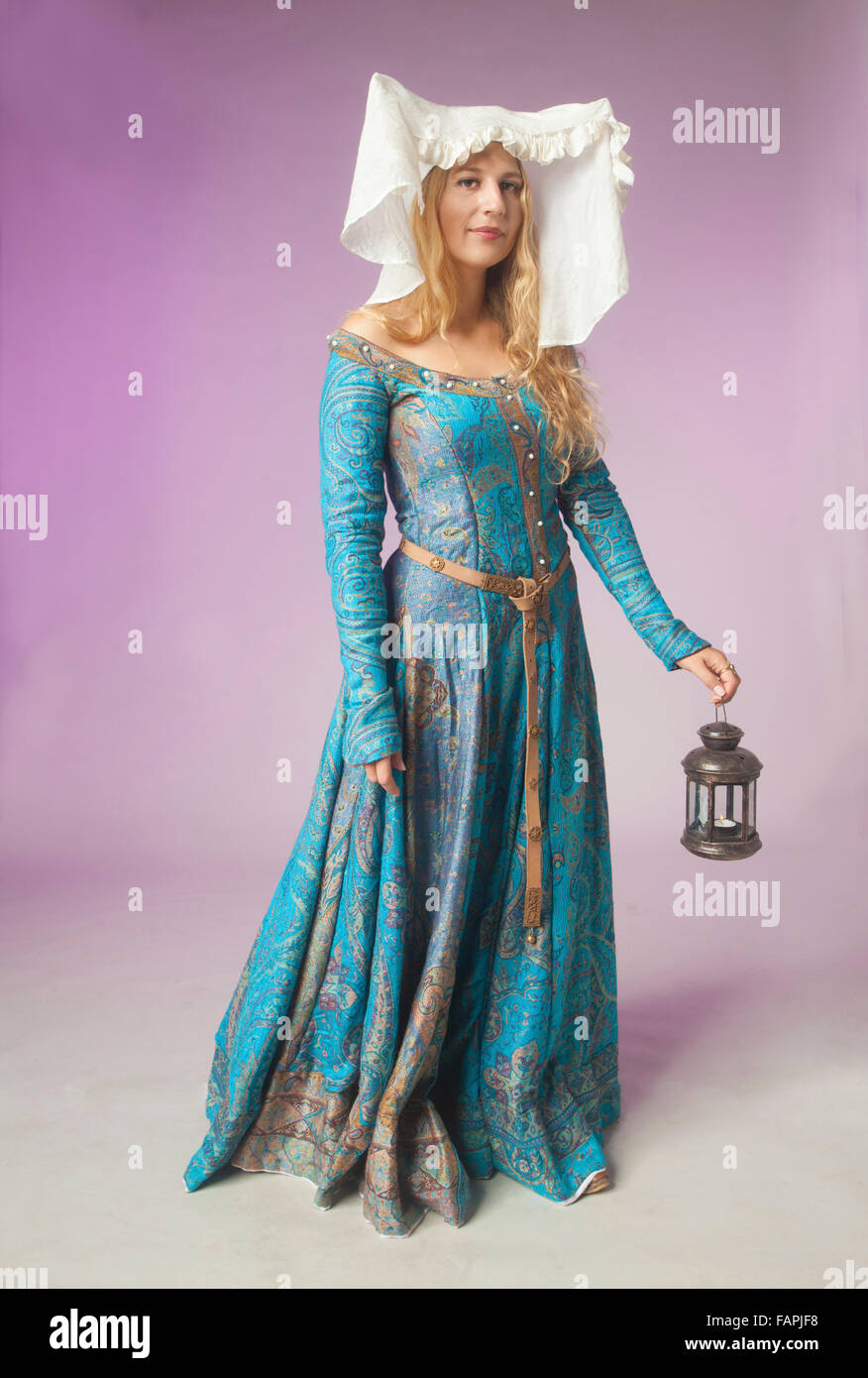 Studio shot of beautiful girl dressed as a medieval lady with a retro ...