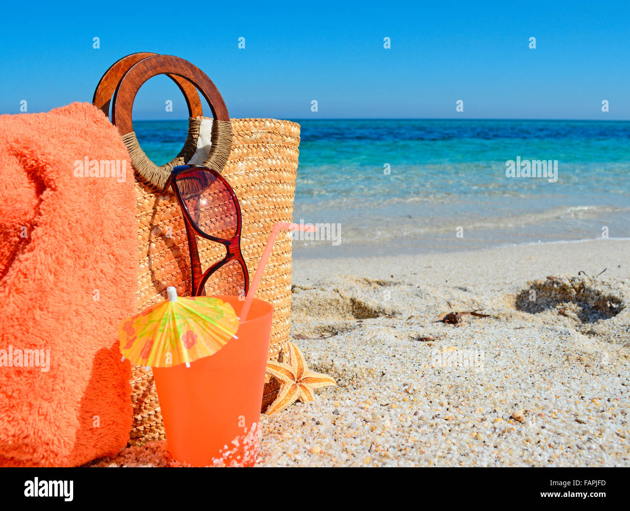 straw bag and sunglasses in the sand in a Sardinian beach Stock Photo ...