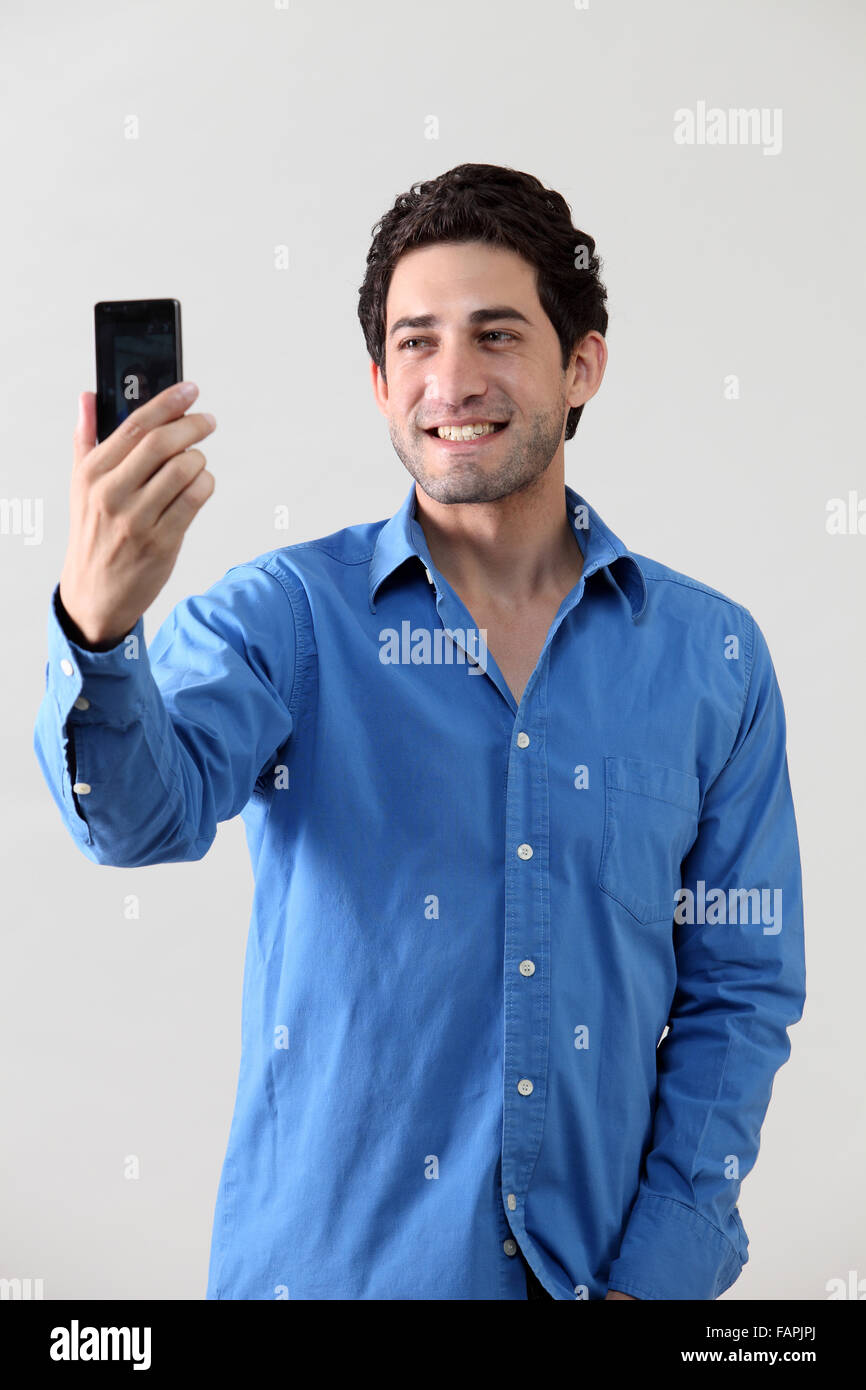 man using mobile phone to take a picture of himself Stock Photo - Alamy
