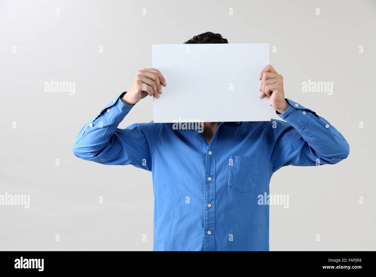 Man holding blank paper cover the face Stock Photo - Alamy