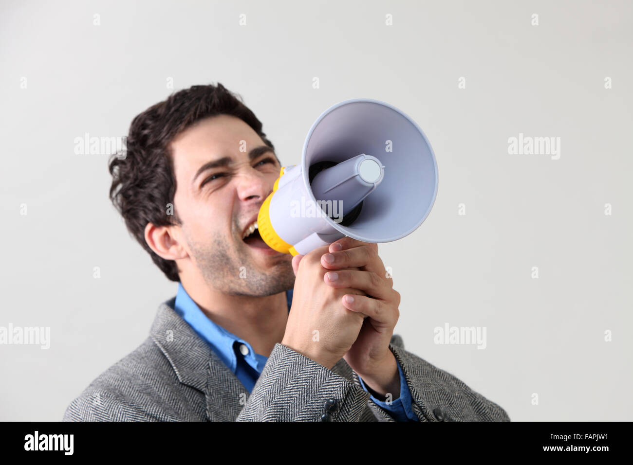 Businessman shouting through megaphone Stock Photo - Alamy