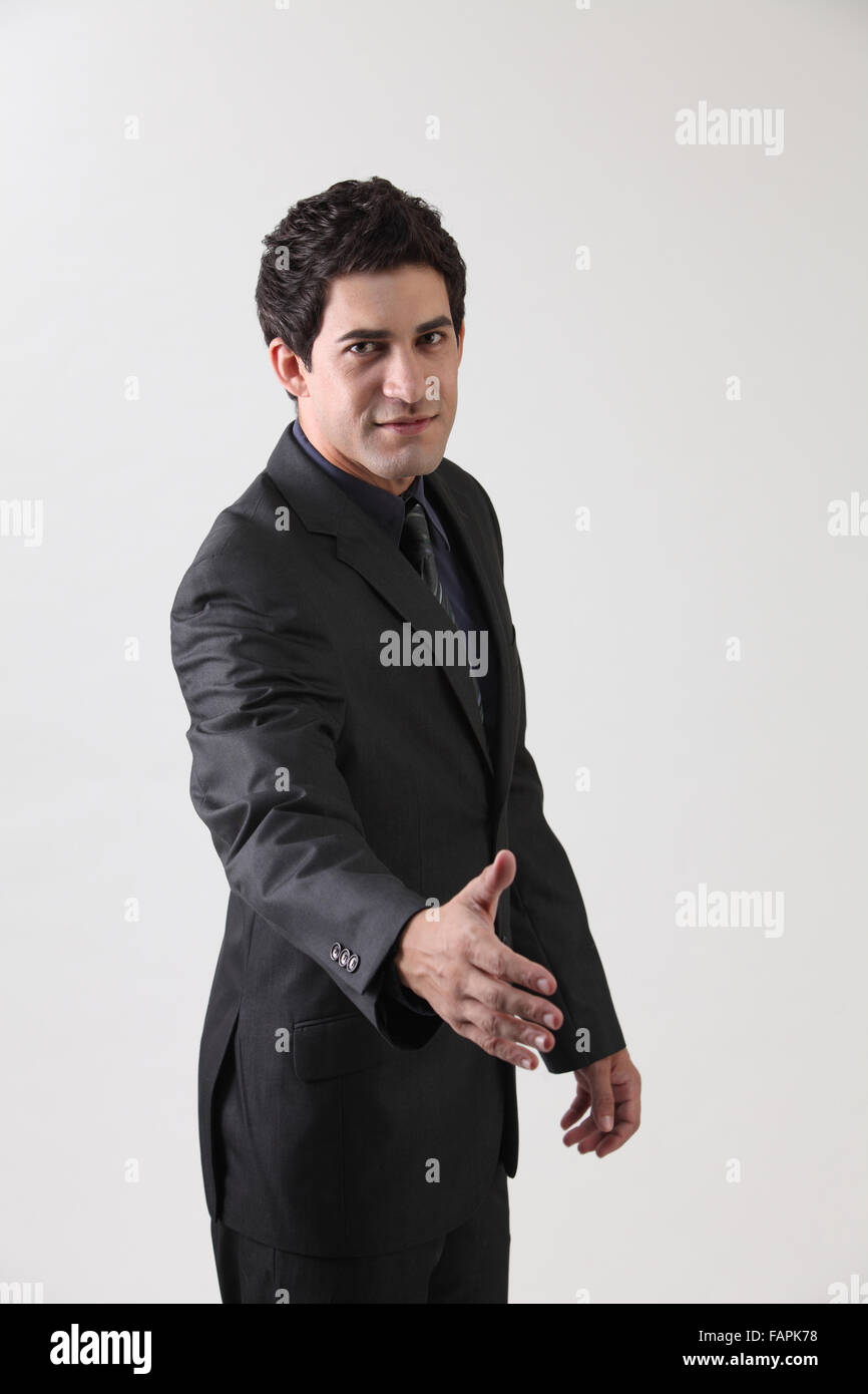 business raised arm about doing a hand shake Stock Photo - Alamy